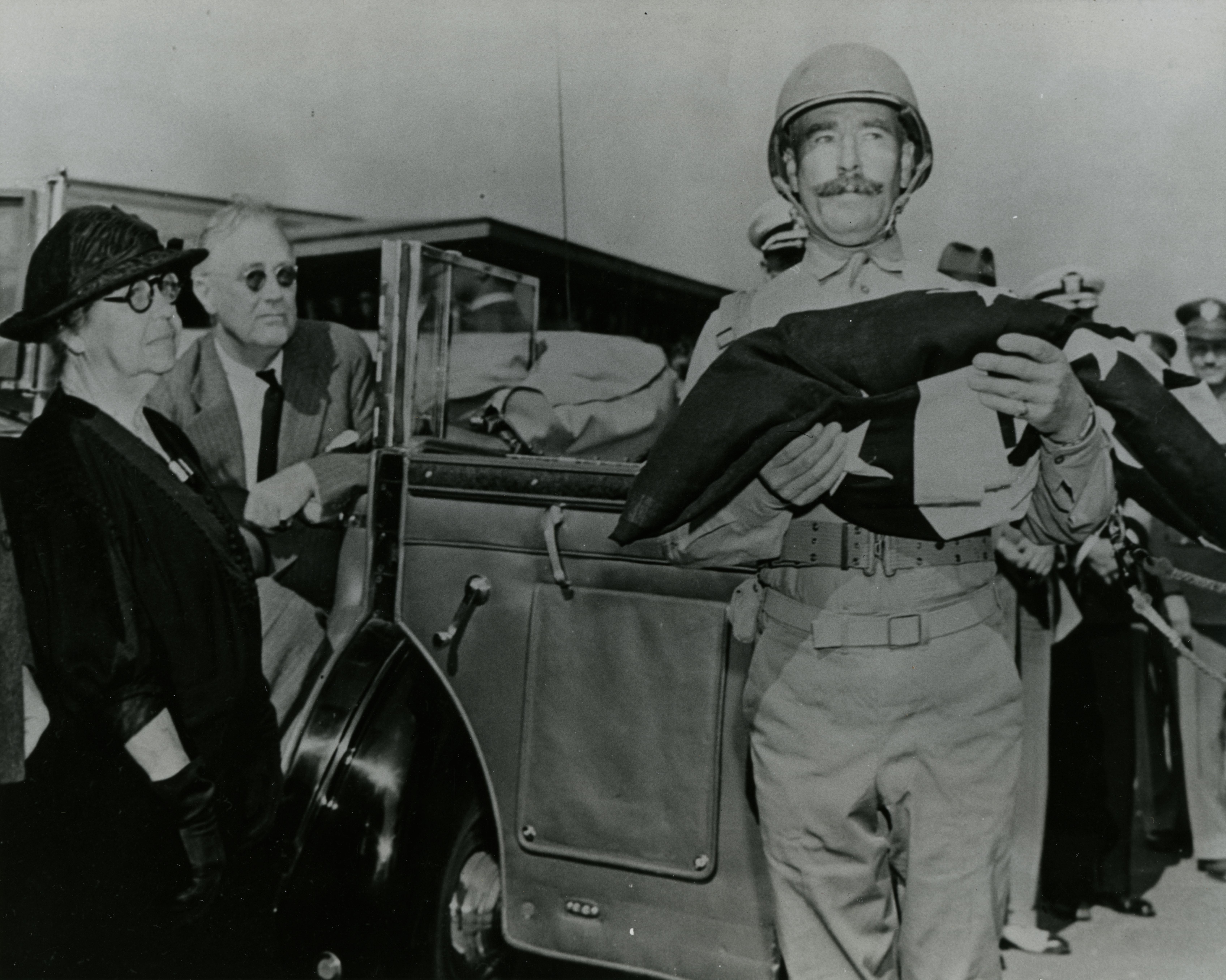 Gunnery Sergeant Carl A. Ostrom, USMC, holds the US Flag prior to the ...