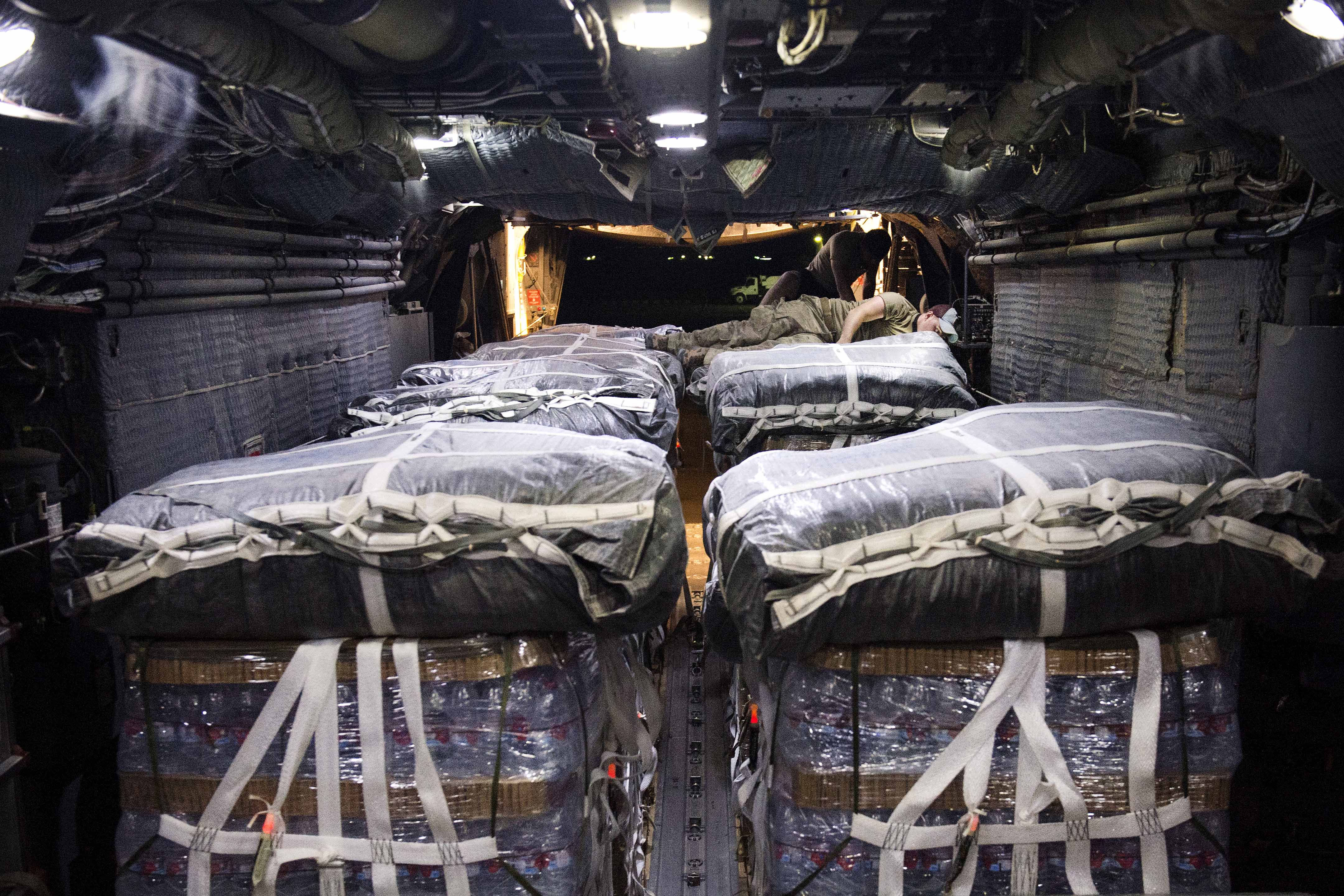 MC-130 Hercules crew chiefs prepare cargo and supplies for an airdrop ...