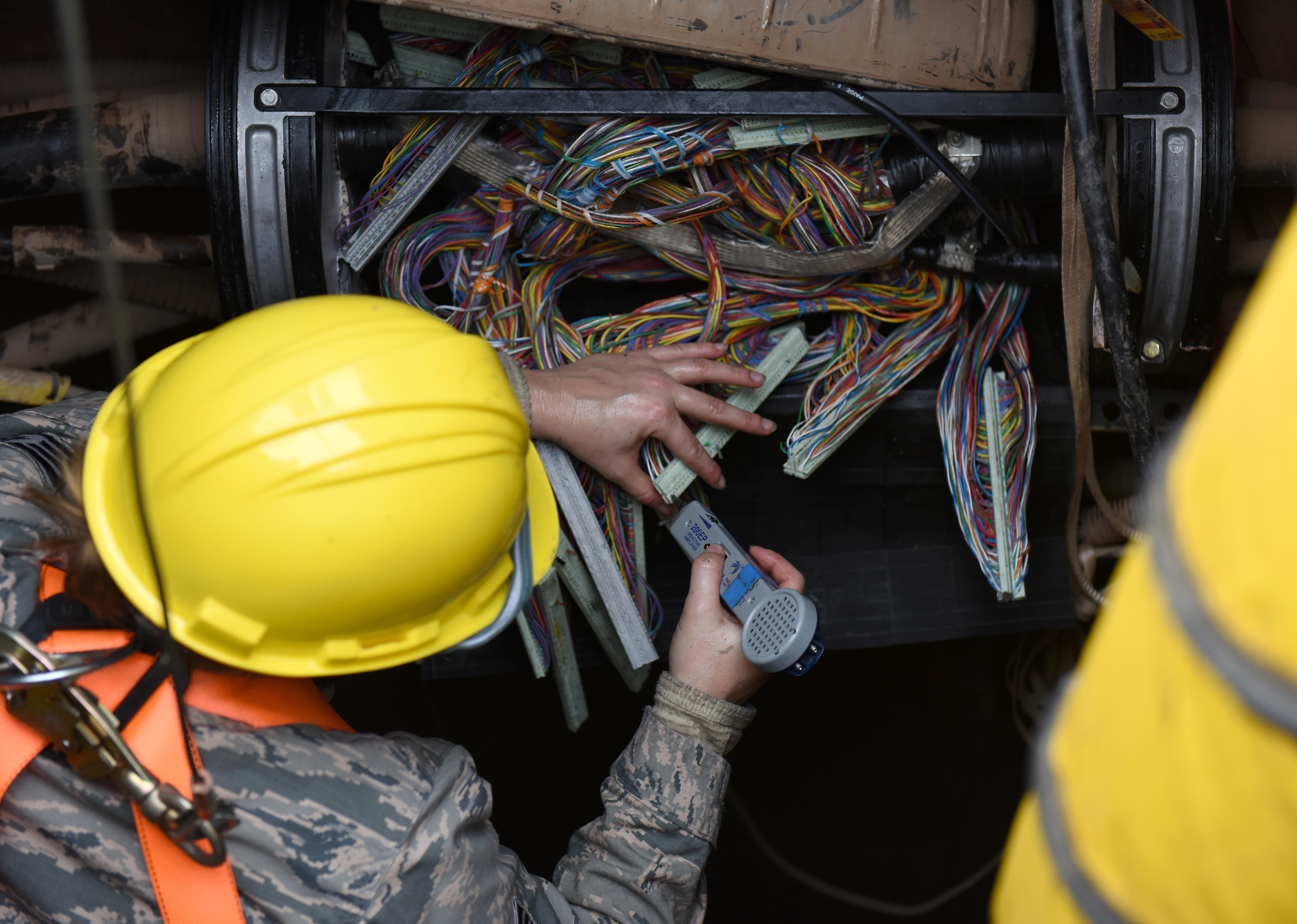 211th Engineering Installation Squadron Airmen install fiber optic ...