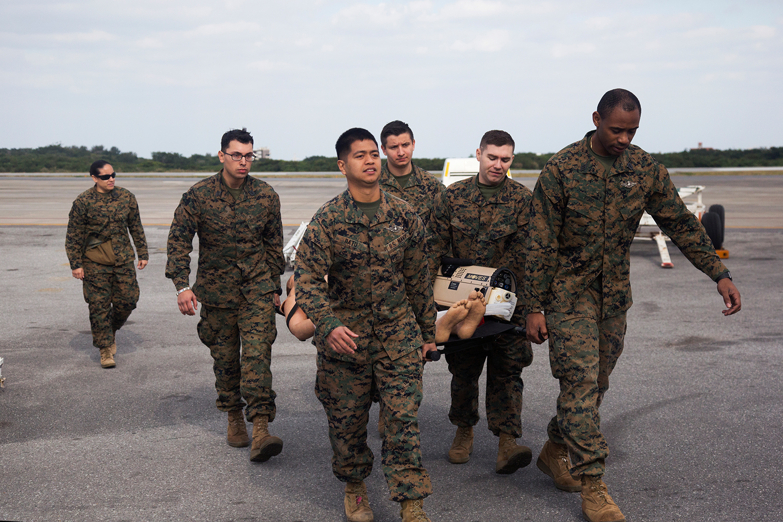 Navy, Army, and Air Force personnel perform en-route medical care training