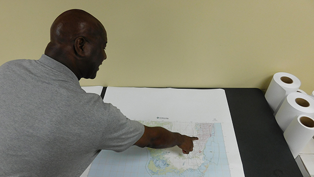 DLA employee point to map location