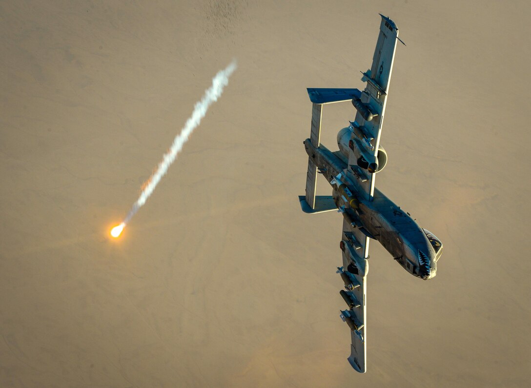 An A-10 Thunderbolt II shoots a flare off after receiving fue