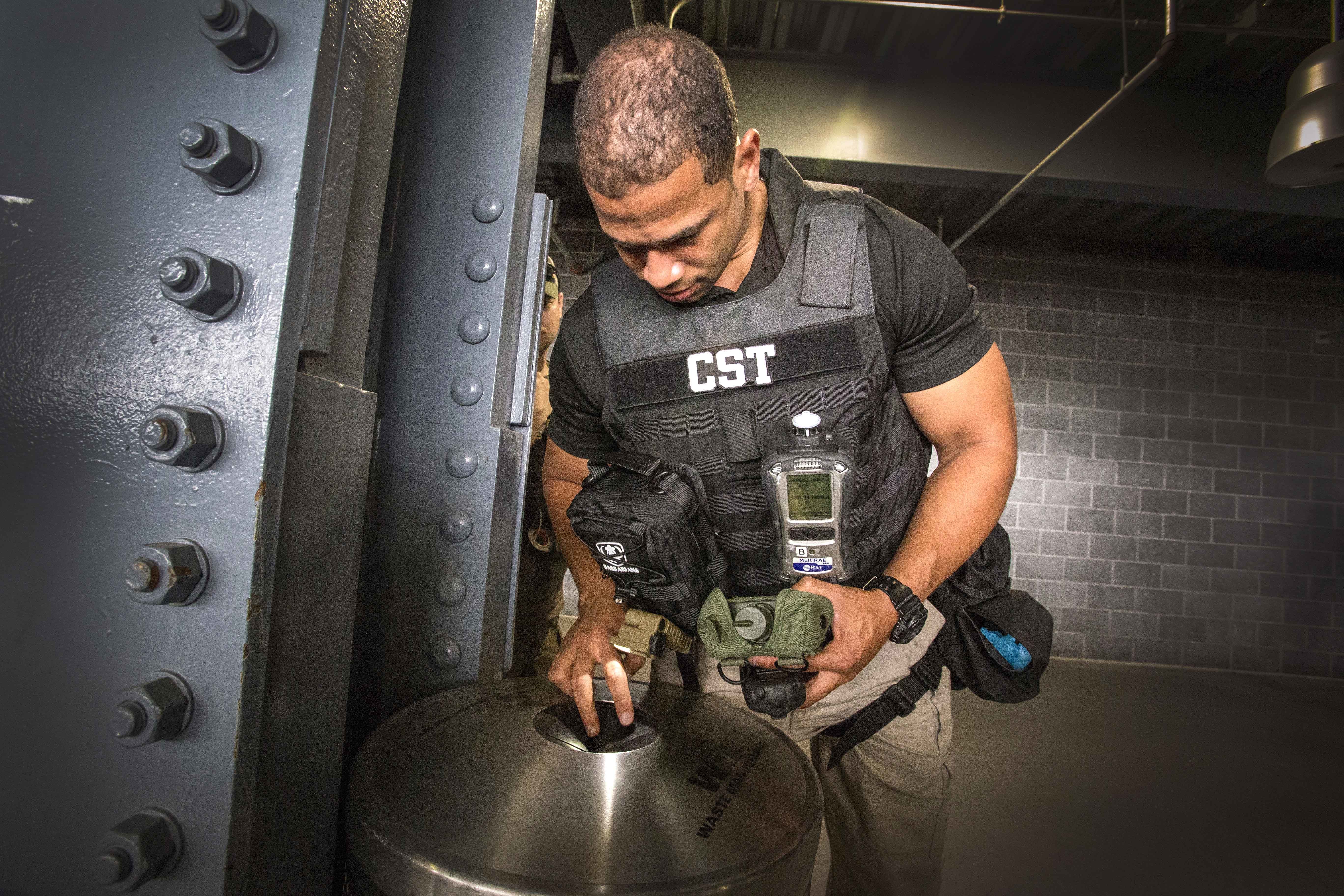 Inspecting Trash Container | U.S. Department of War