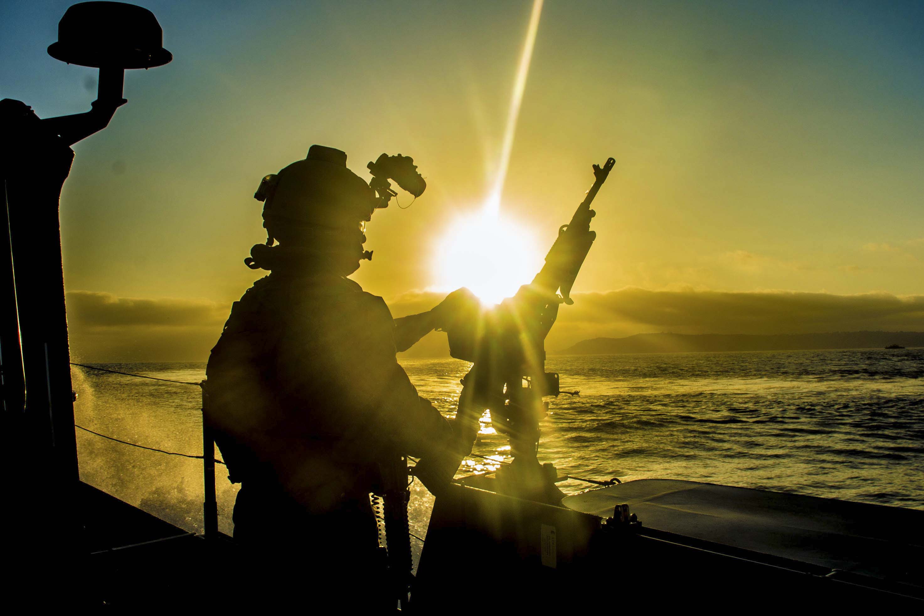 Navy Chief Petty Officer Bryan Barcena mans an M240 machine gun during ...