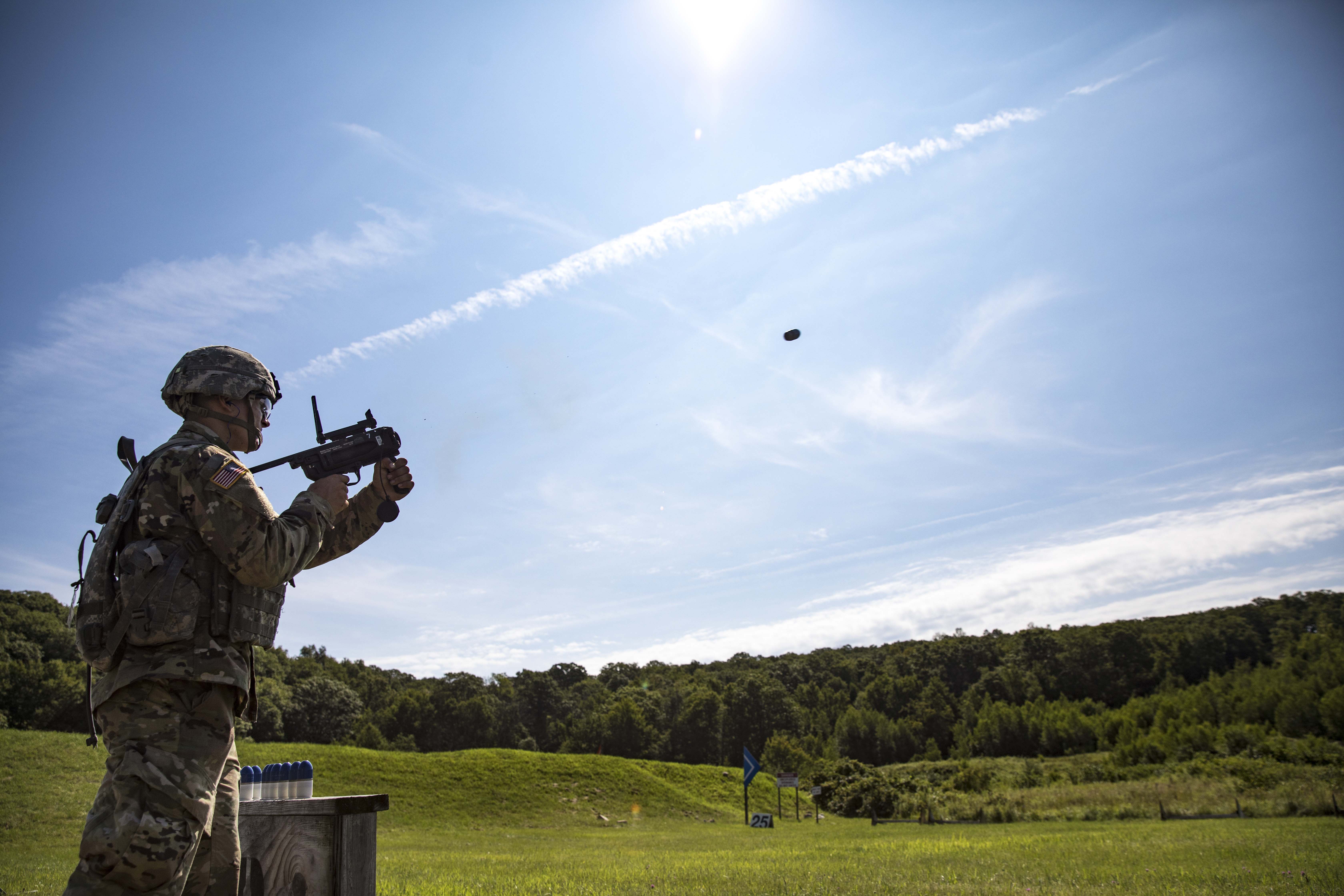 A Marine Corps recruit shoots an M320 grenade launcher during training ...