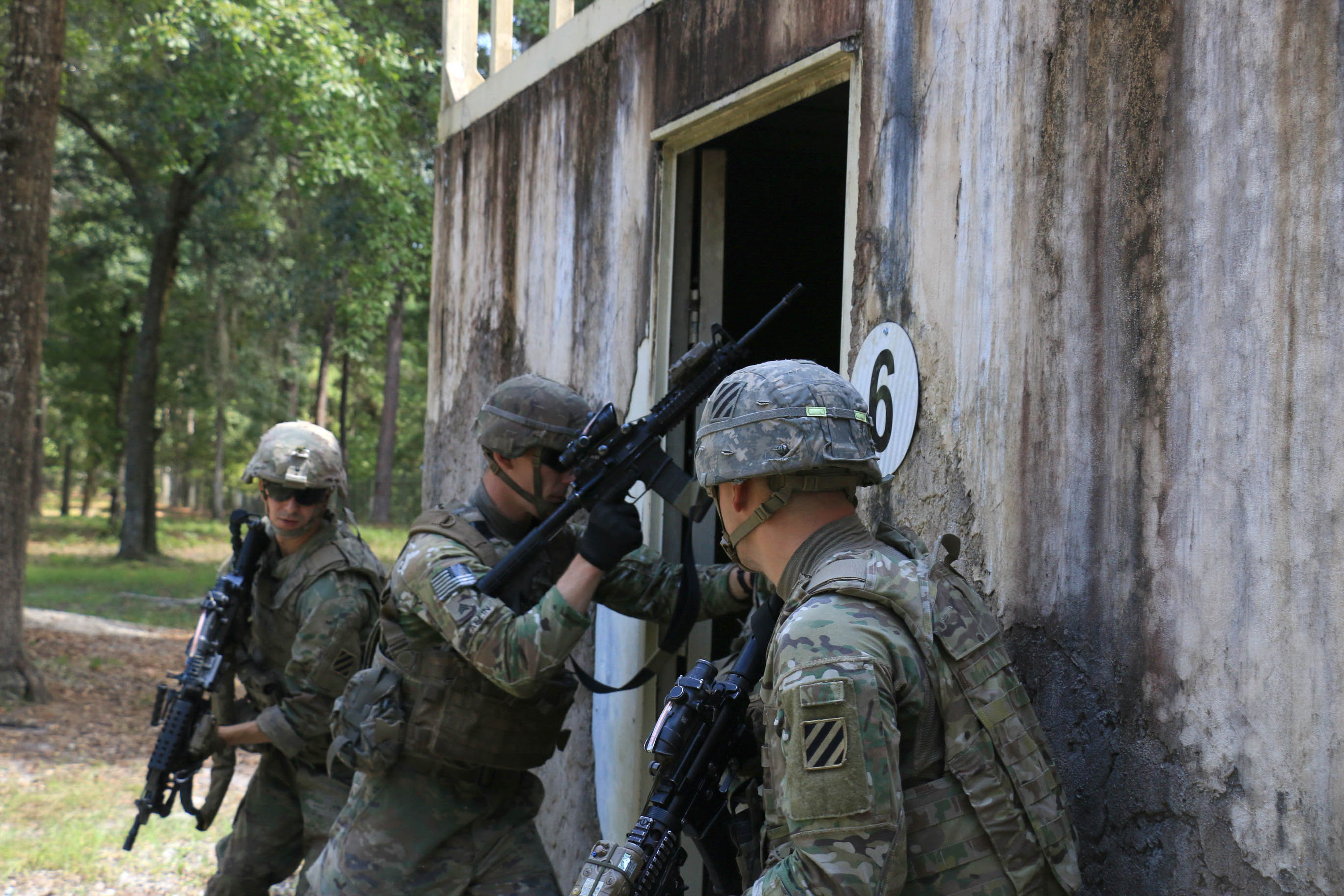 Soldiers breach the entry point of a building during Battle Drill VI, a ...