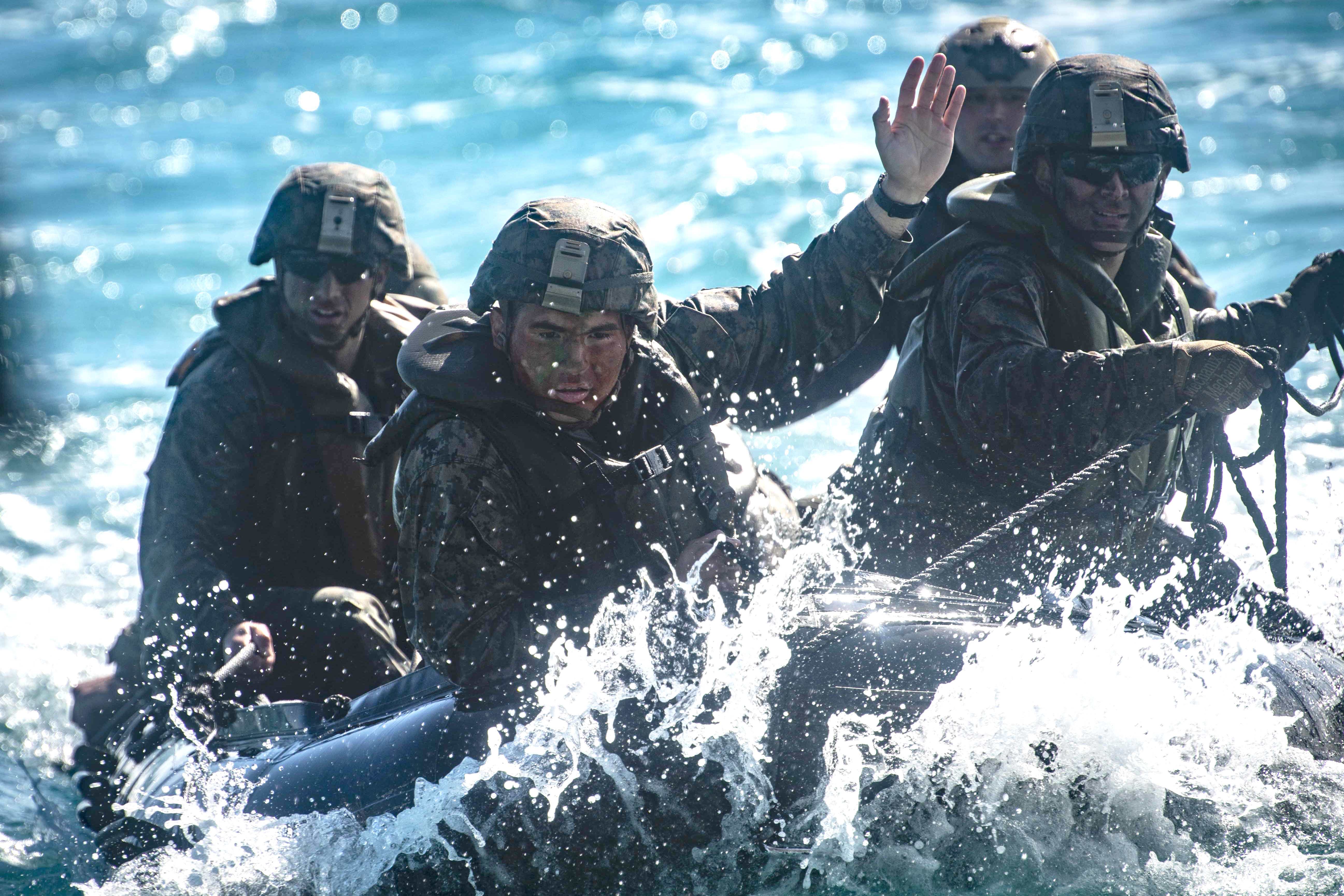 Marines prepare a safety line in a combat rubber raiding craft during ...