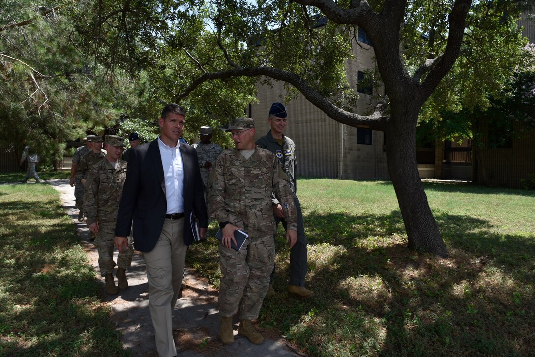 An assistant SECAF and 19th Air Force commander listen to Laughlin