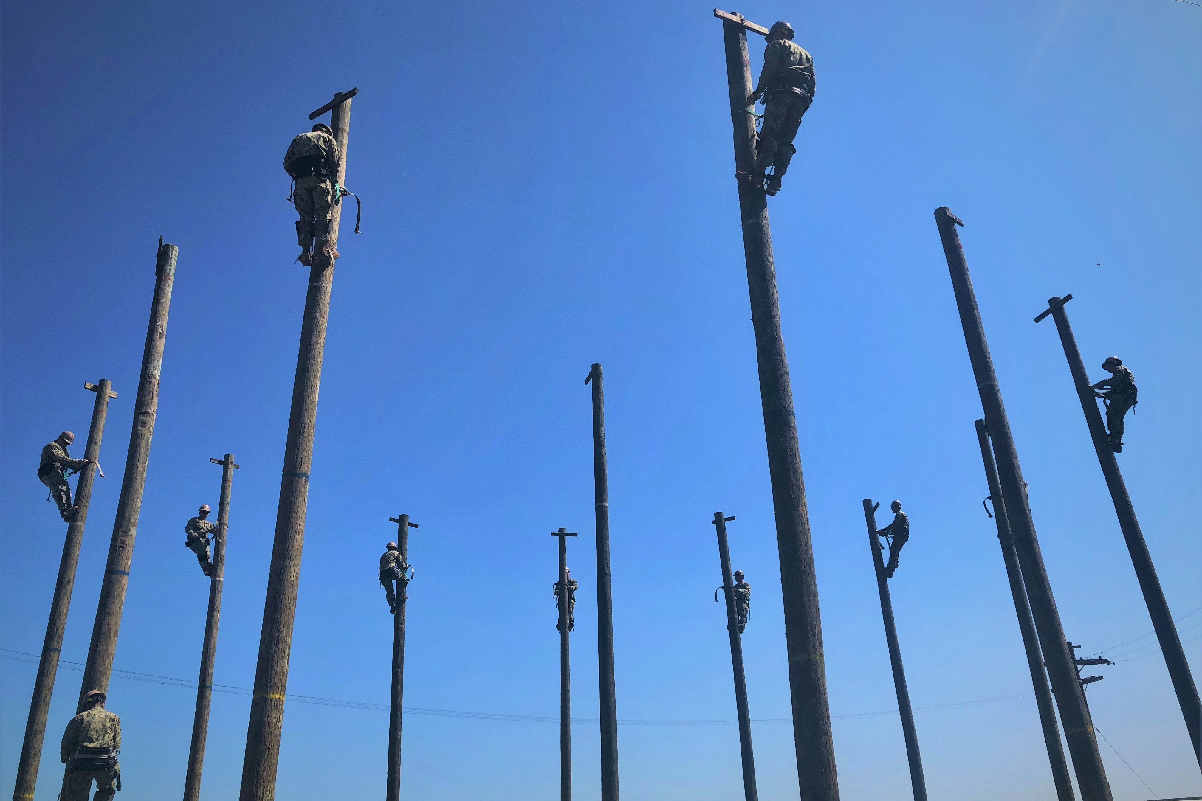Navy Seabees practice wooden power pole utility skills during a three ...