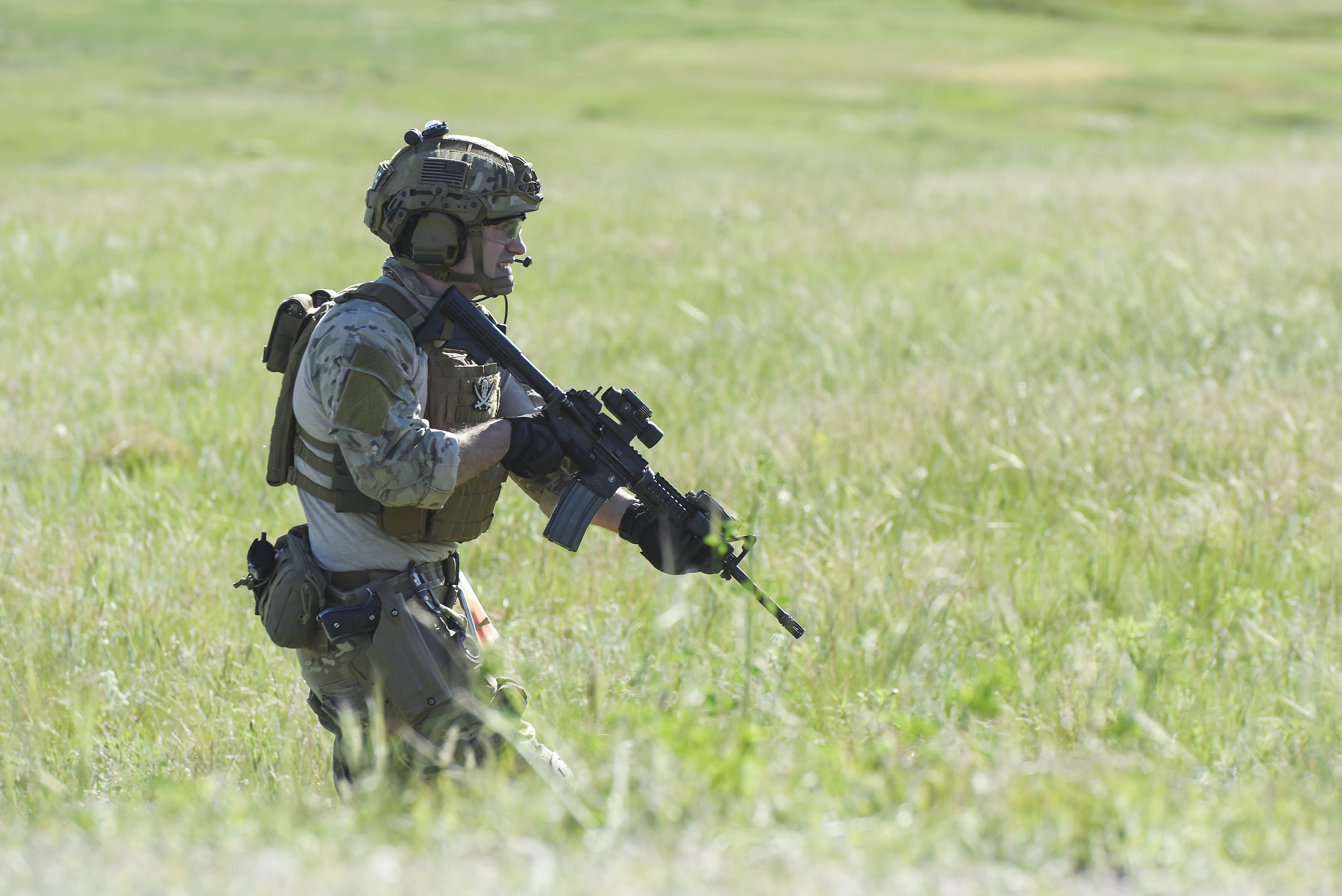 An airman moves through a field during integrated recapture and ...