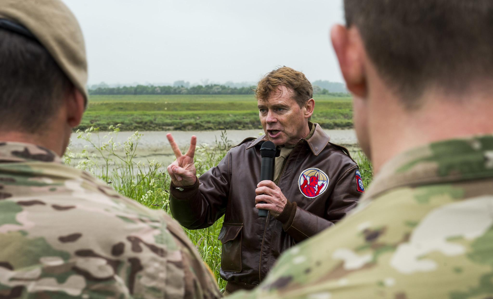 a volunteer tour guide, explains details of a WWII battle that took ...
