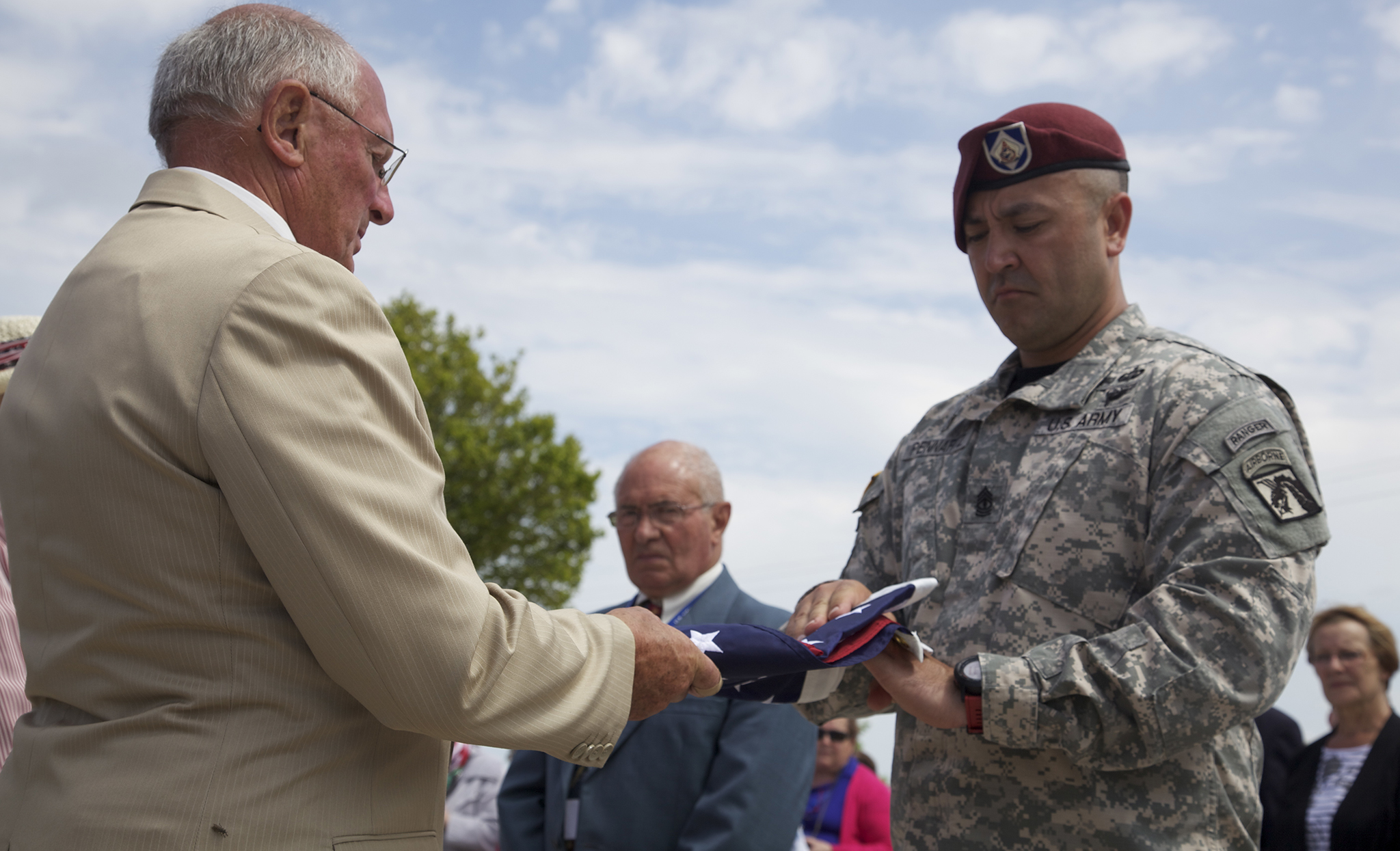 U.S. Army 1st Sgt. Timothy Pennartz of the 18th Airborne Corps, folds ...