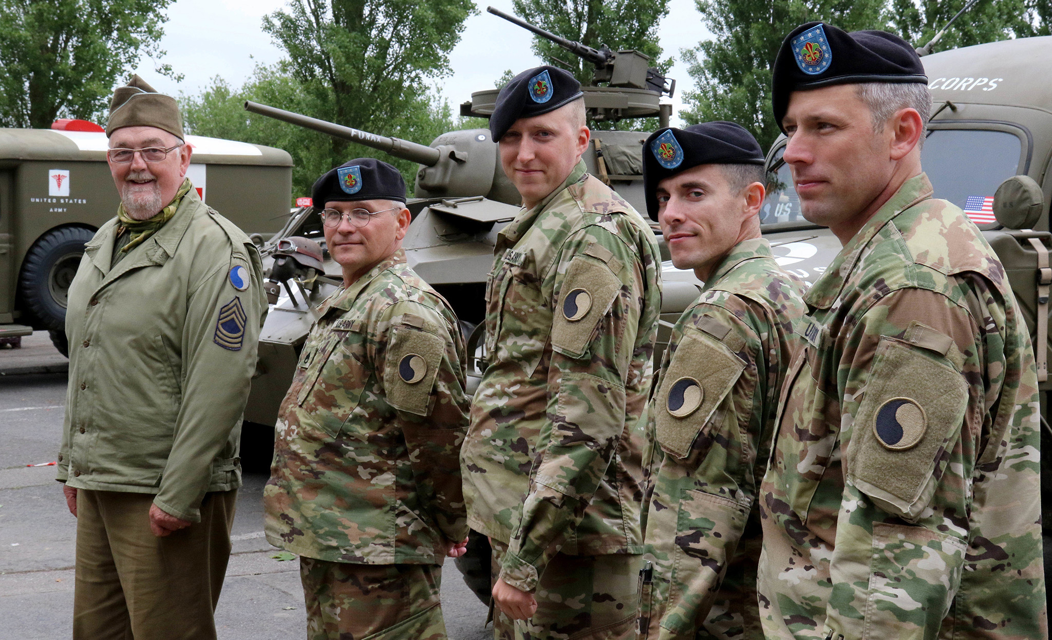 90th Infantry Division Soliders pose with a WWII reenactor after a ...