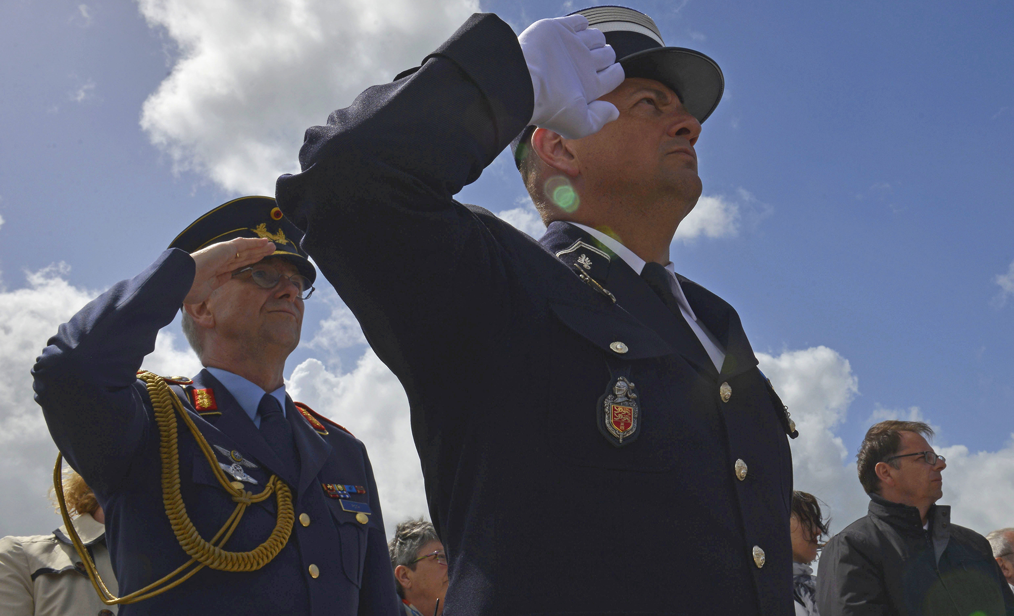 Military dignitaries salute during a ceremony in Sainte-Marie-du-Mont ...