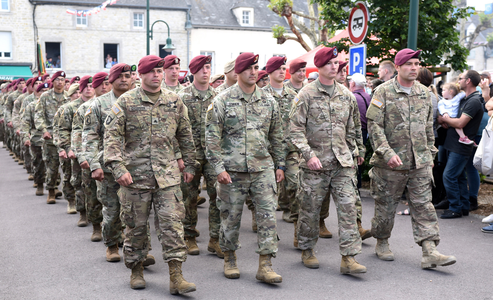 U.S. Army Paratroopers march through Sainte Mere Eglise, France