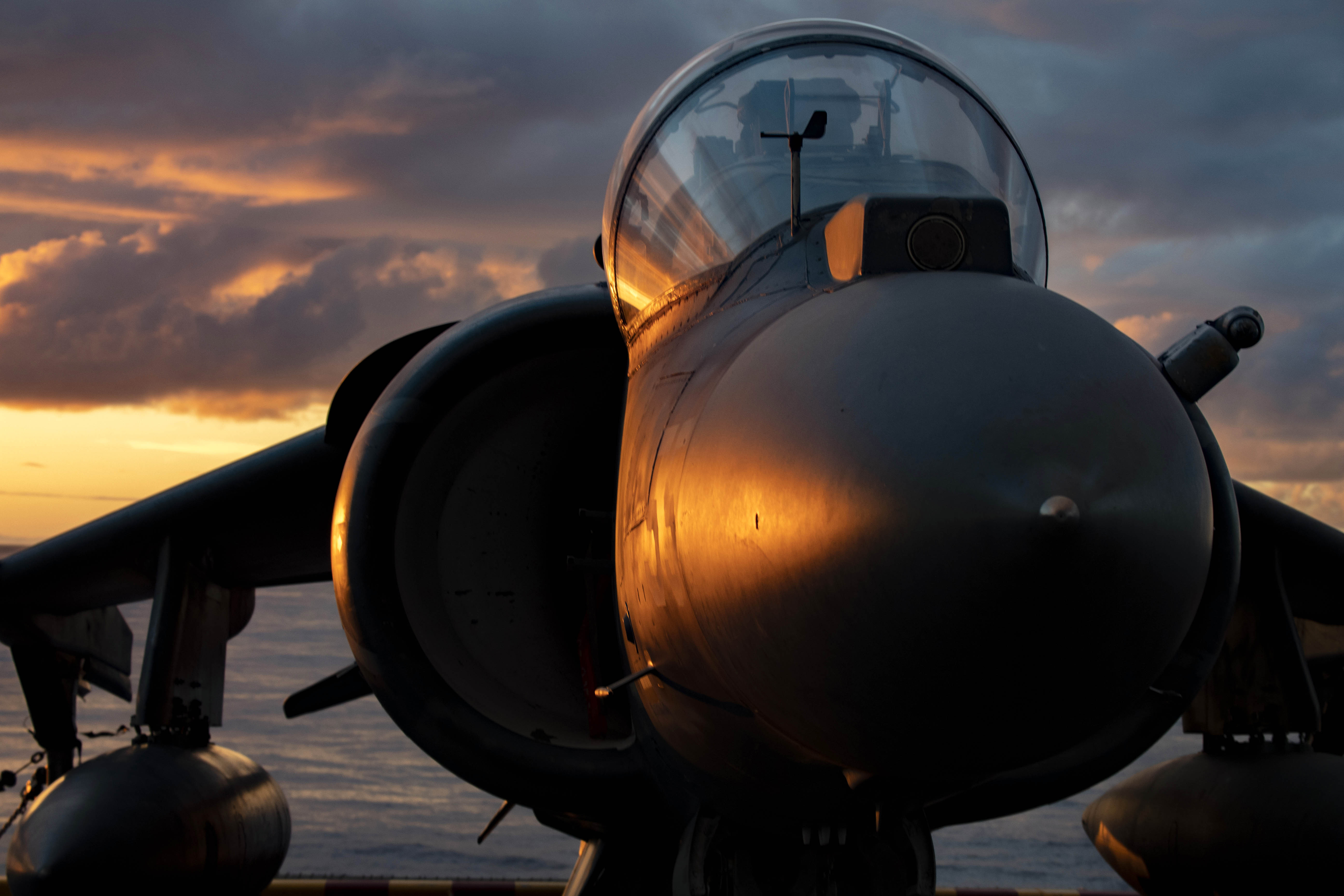 Sunlight reflects off a Marine Corps AV-8B Harrier II on the flight ...