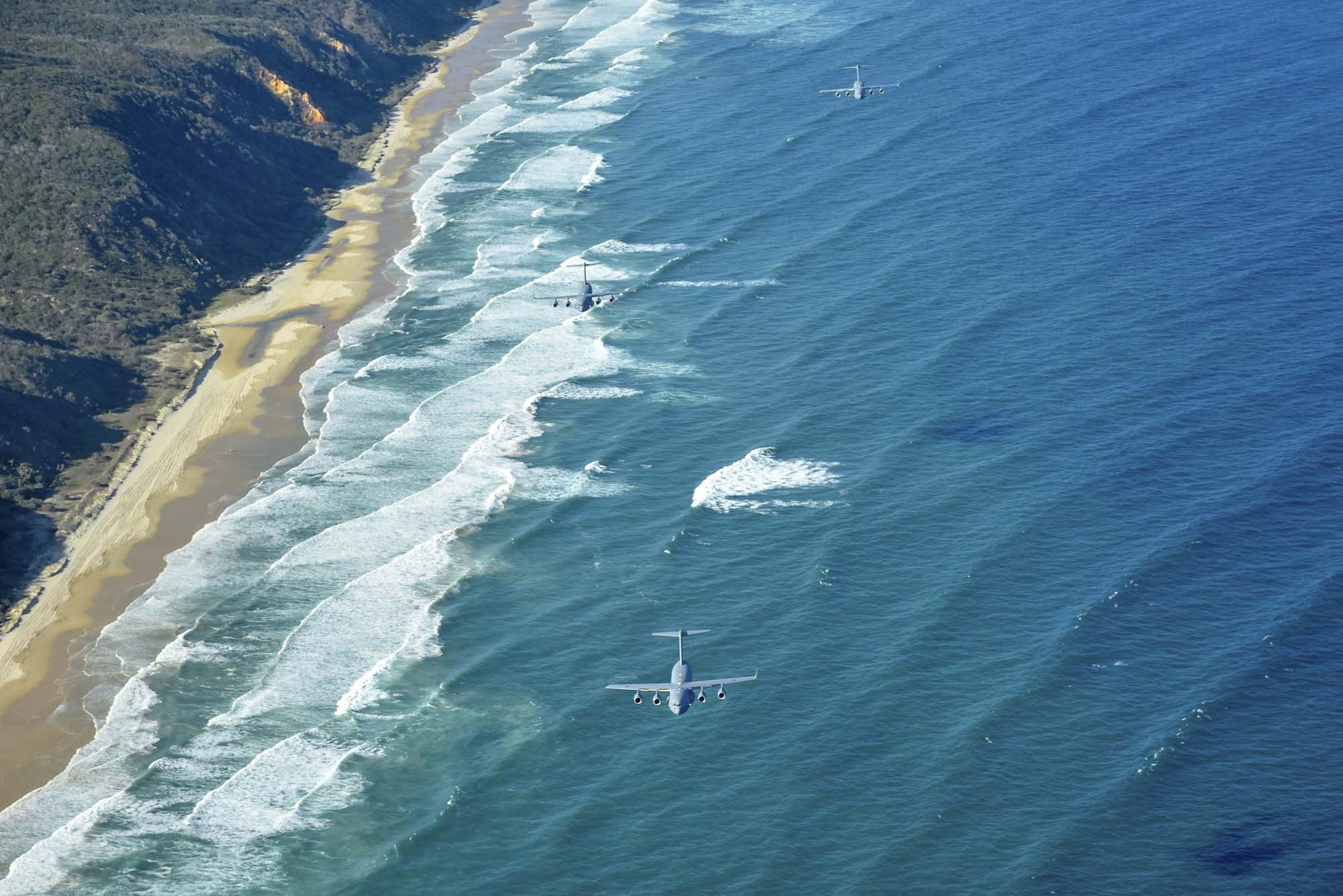 U.S. and Australian air force C-17A Globemasters conduct a flight along ...