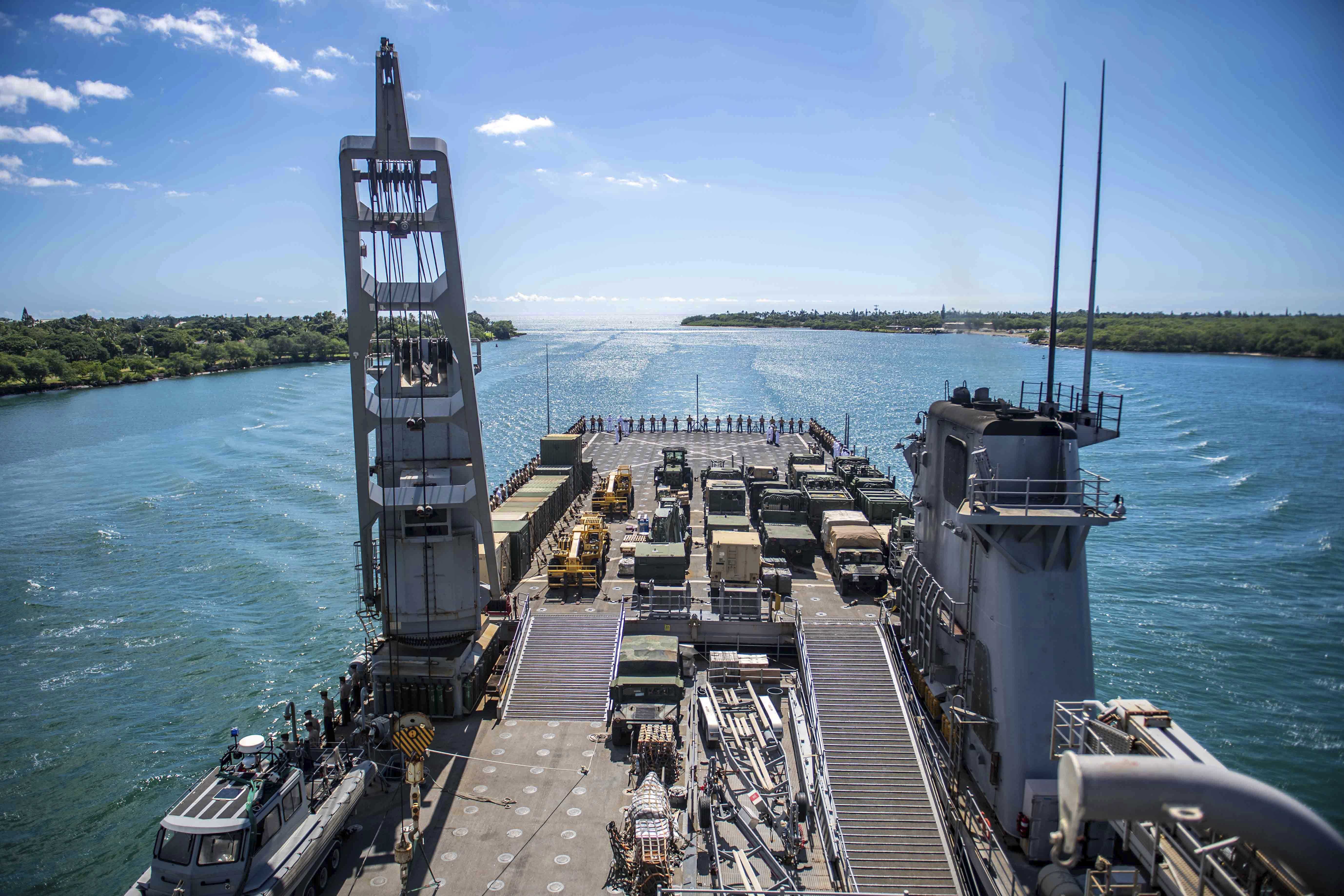 Sailors and Marines man the rails of the USS Harpers Ferry as the ship ...