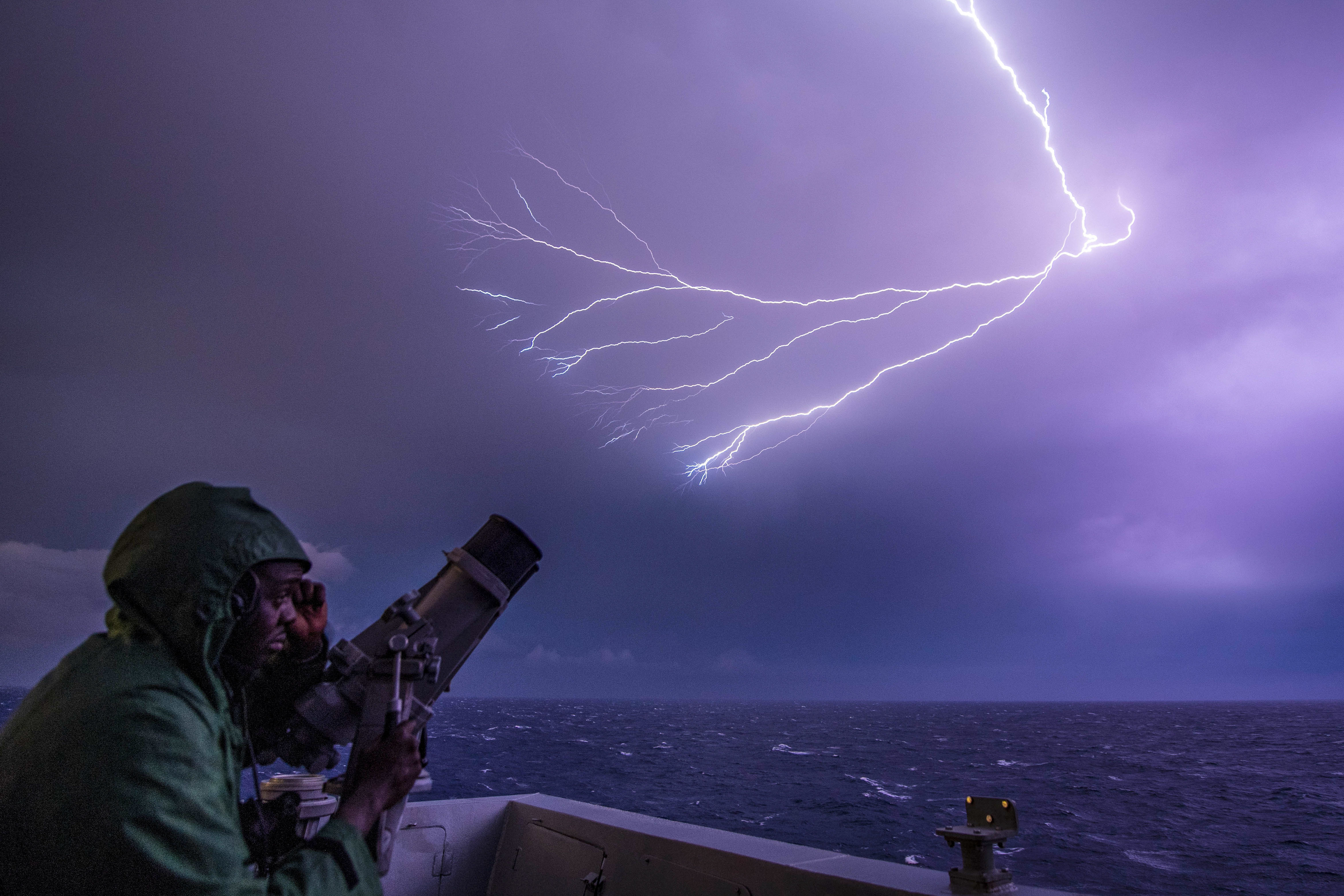 Navy Seaman Rakeem Williams stands watch aboard the USS John P. Murtha ...