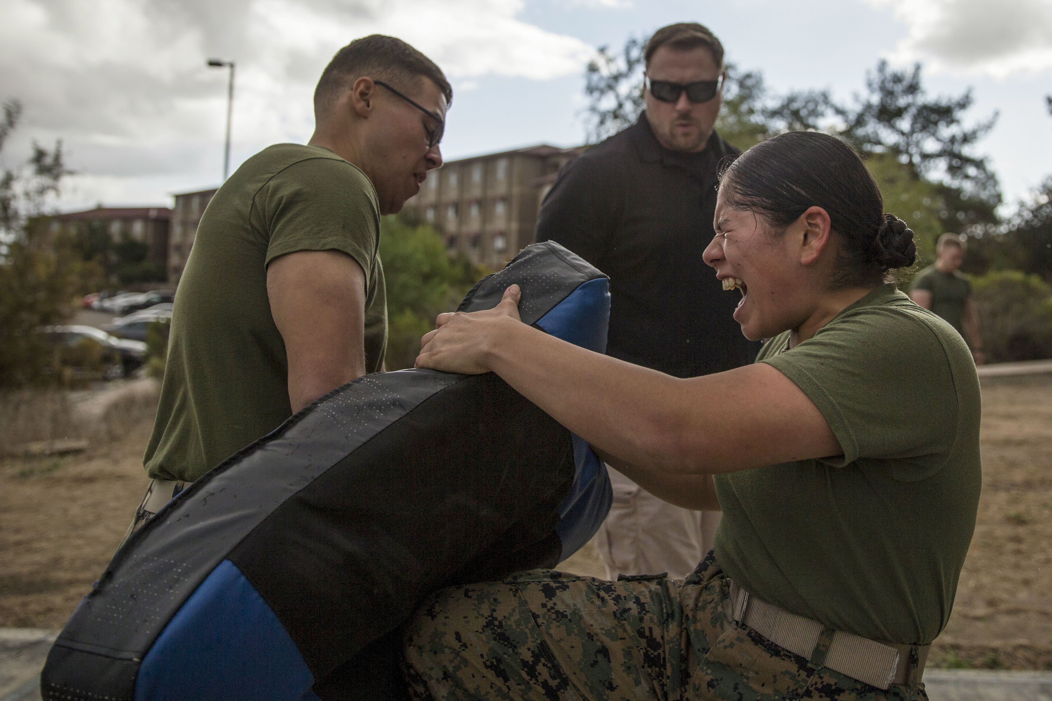 Marine Corps Lance Cpl. Nora Brennon knees a strike pad after being ...