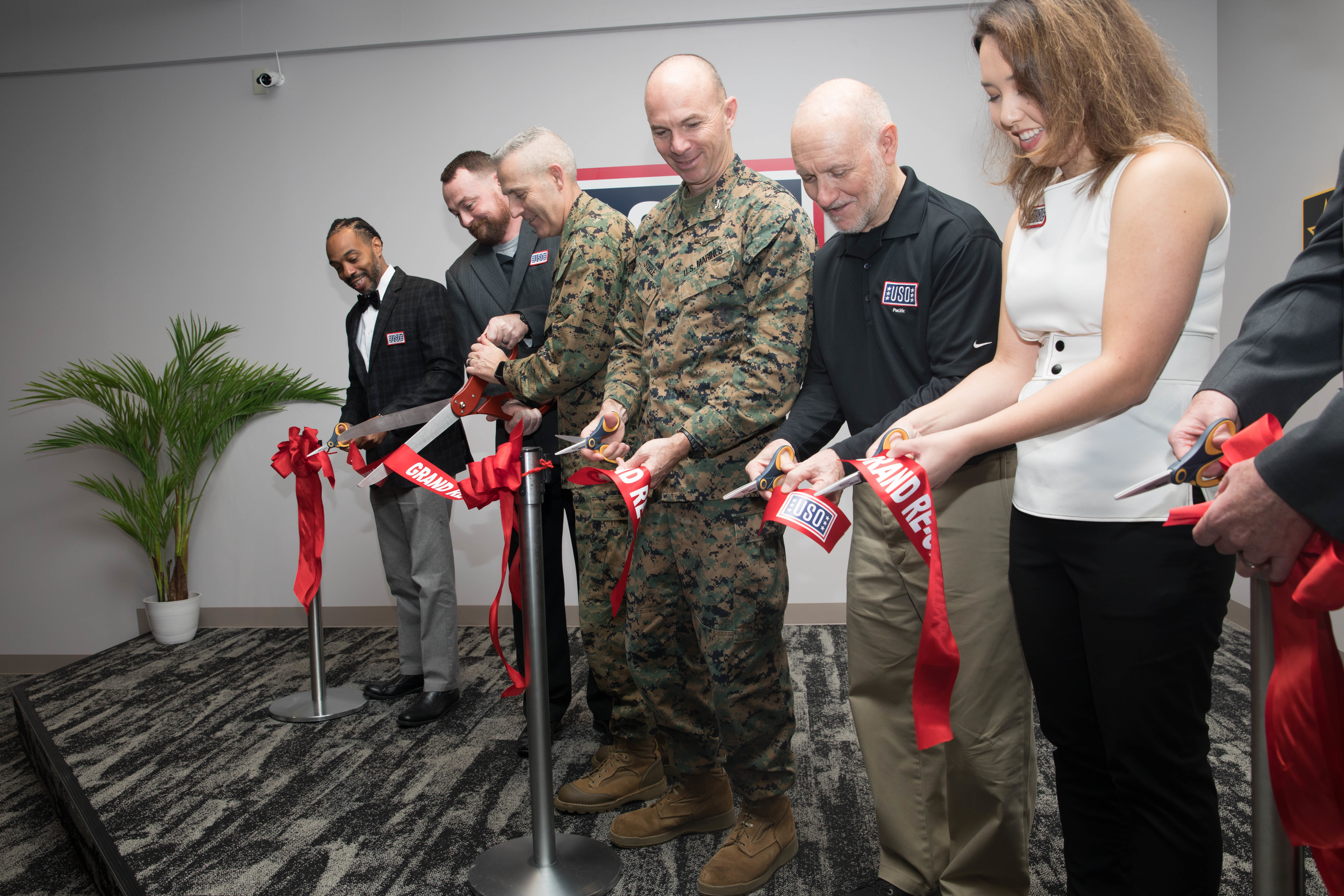 U.S. Marines and members of the United Service Organizations (USO) cut ...