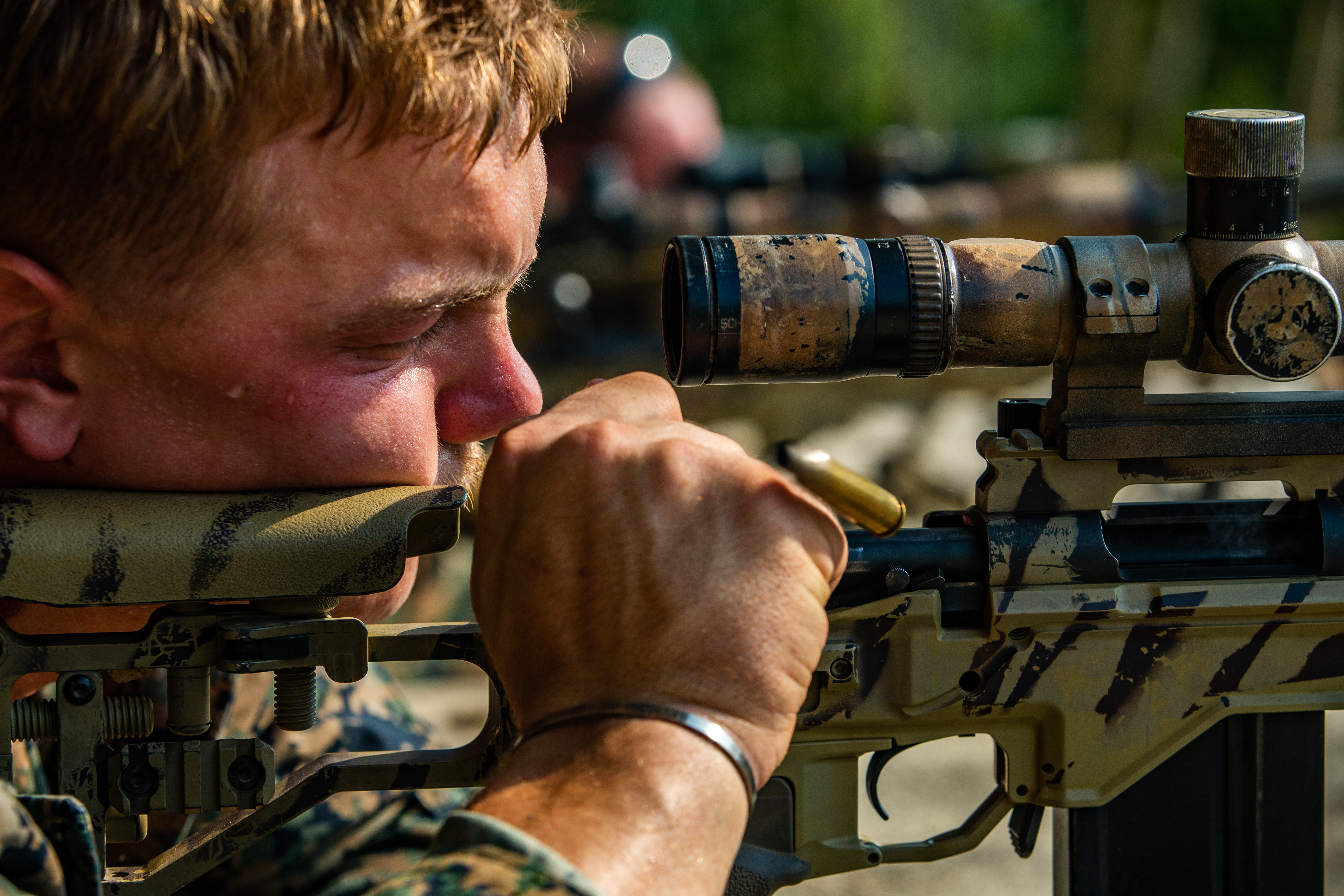 A U.S. Marine racks the bolt of an M40A6 sniper rifle during a ...