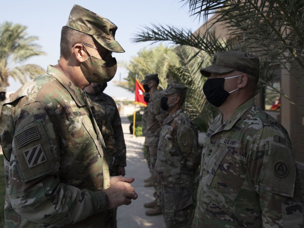 Lt. Gen. Terry Ferrell coins Soldiers for combating COVID-19