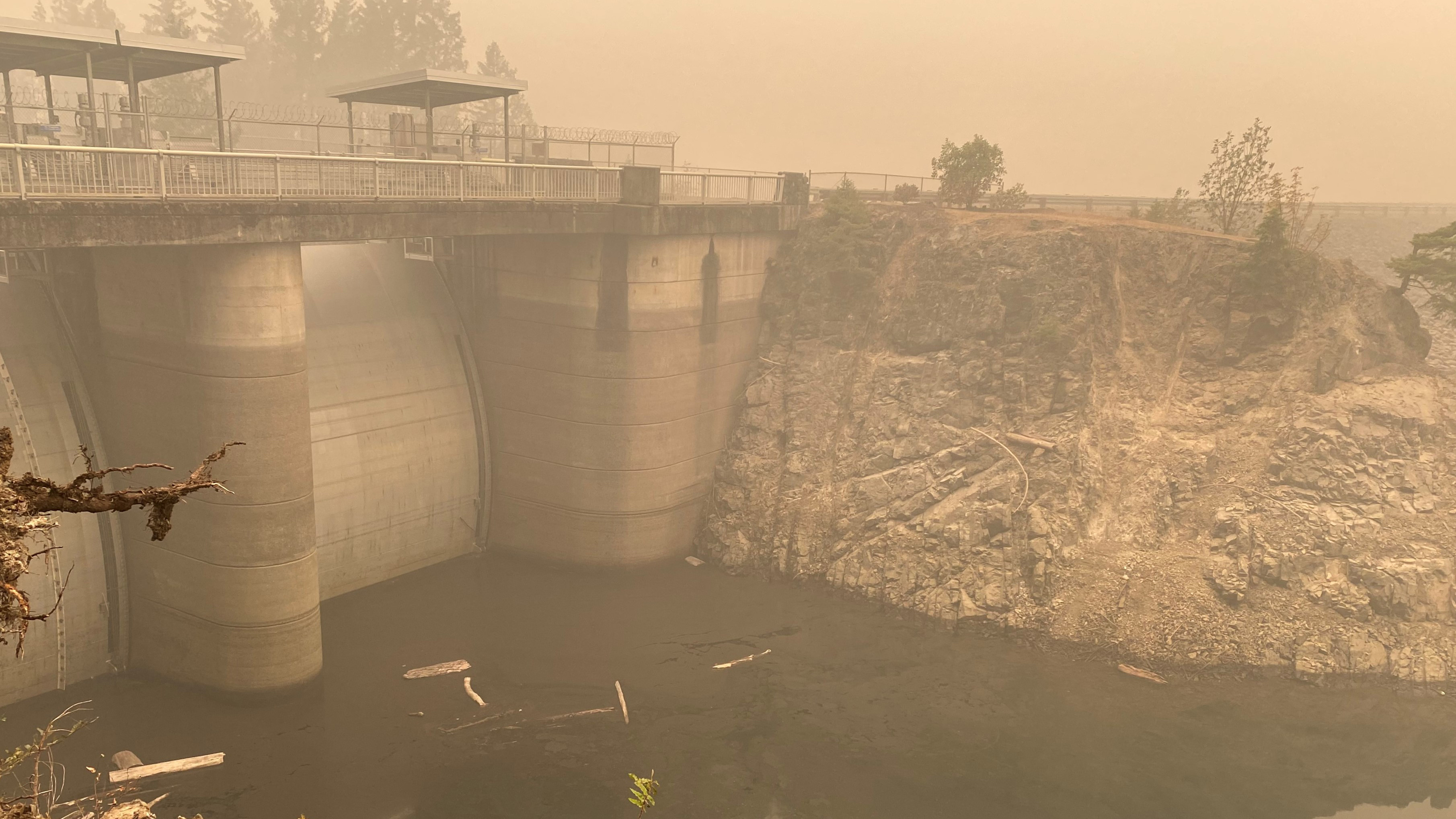 Smoke hangs heavy in the air around the Blue River Dam spillway Sept ...