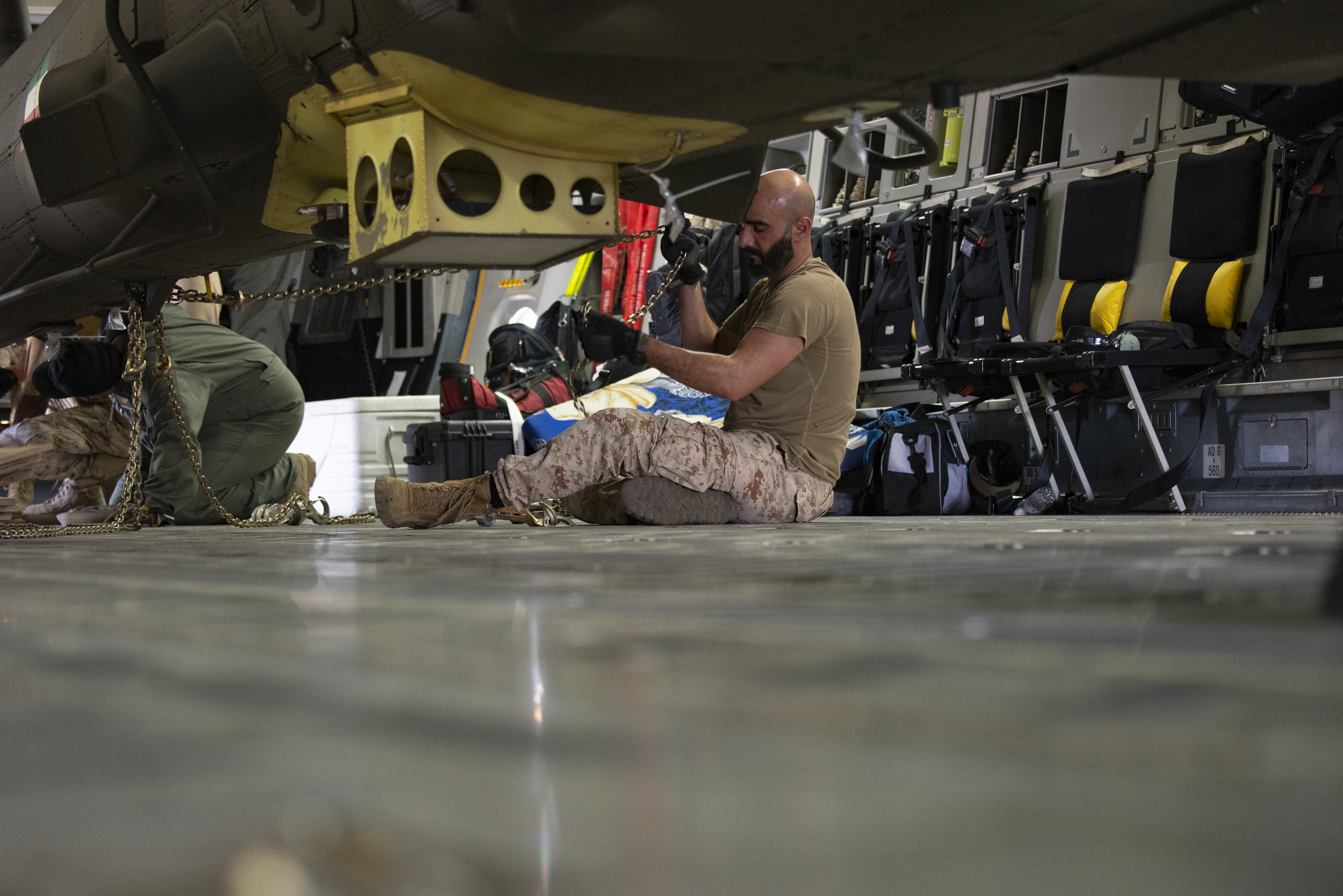 U.S., host nation Air Force members load cargo onto a Kuwait C-17 ...