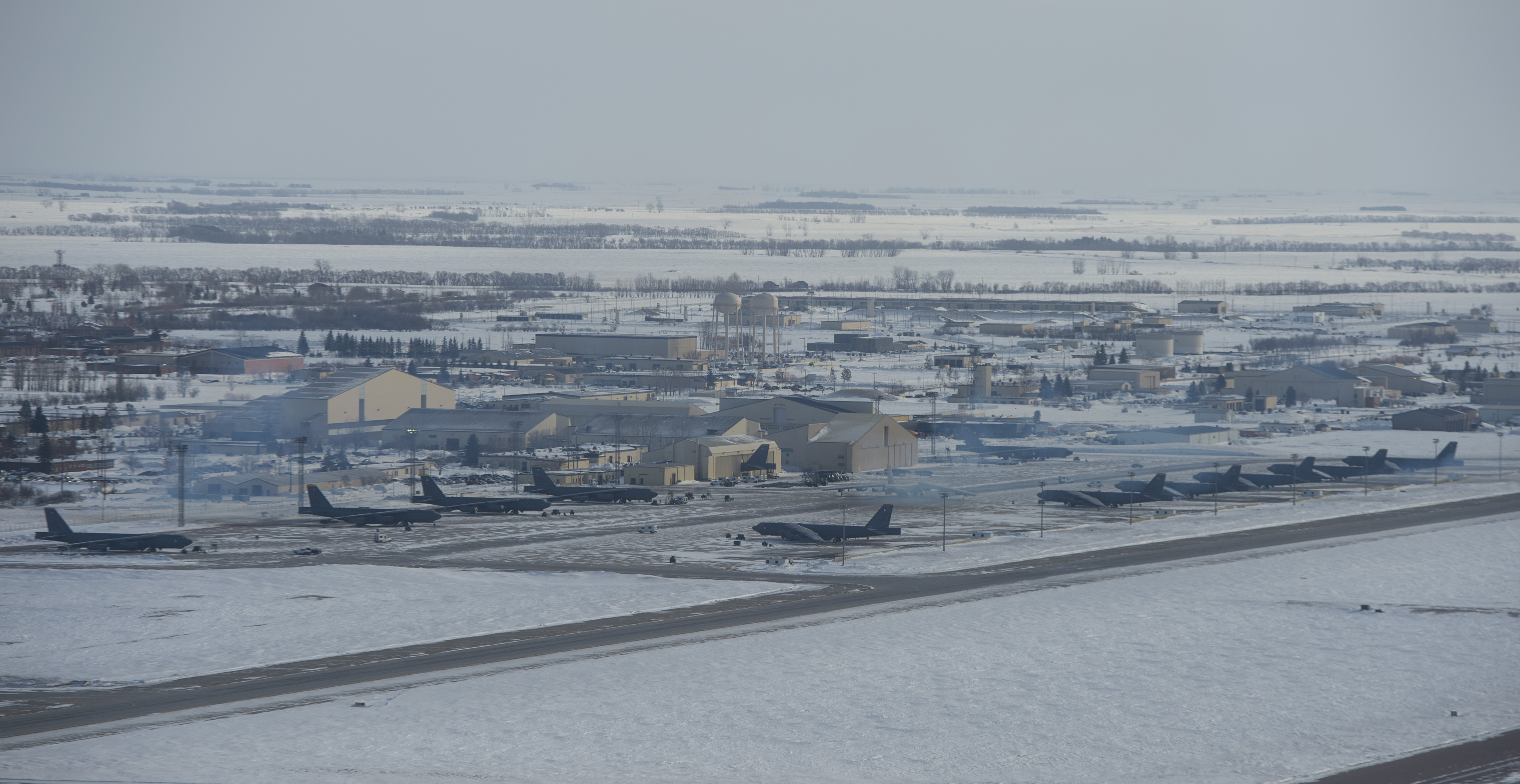 B-52 Stratofortresses are parked along the flightline at Minot Air ...