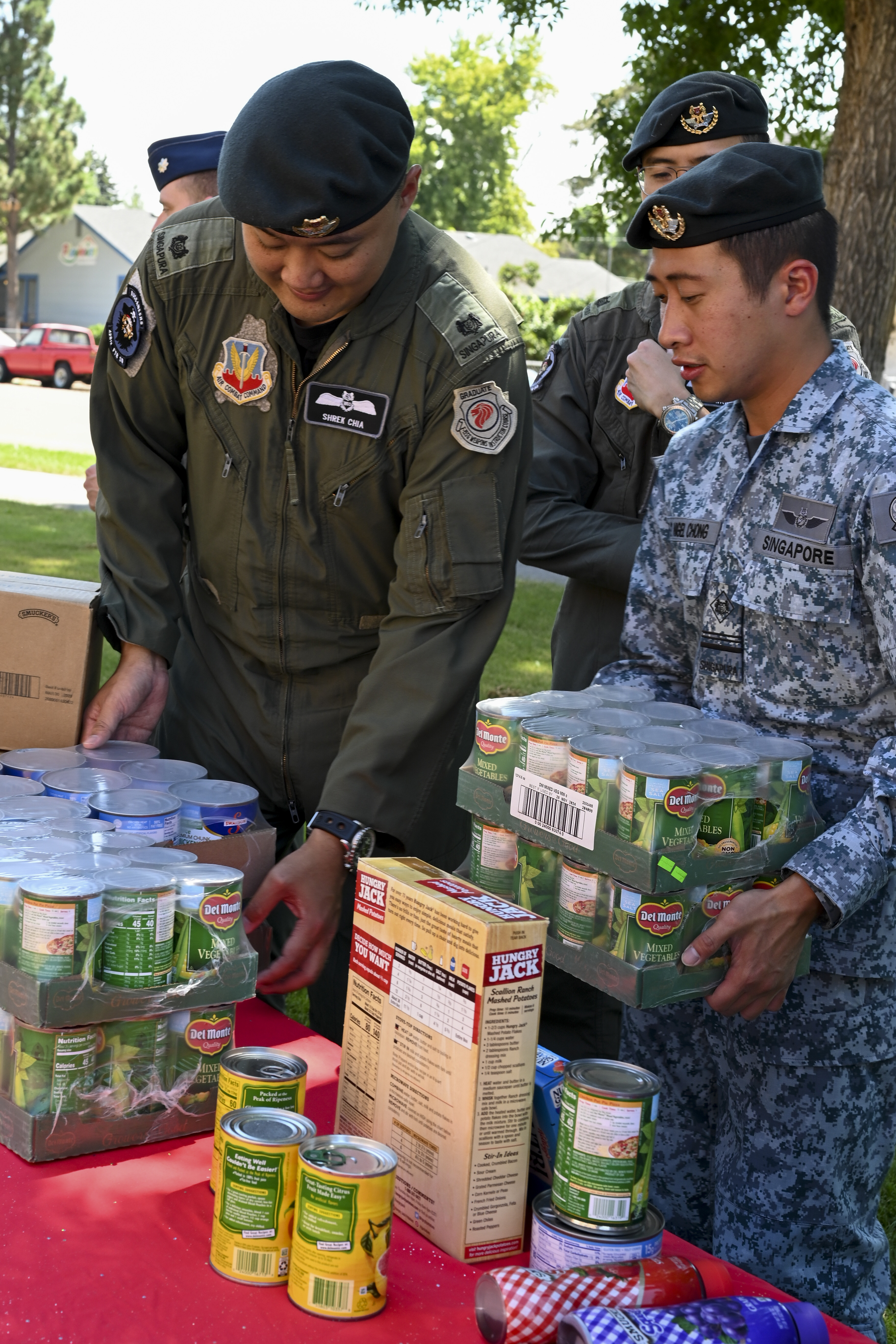 428th Fighter Squadron, RSAF members donate food to community ...