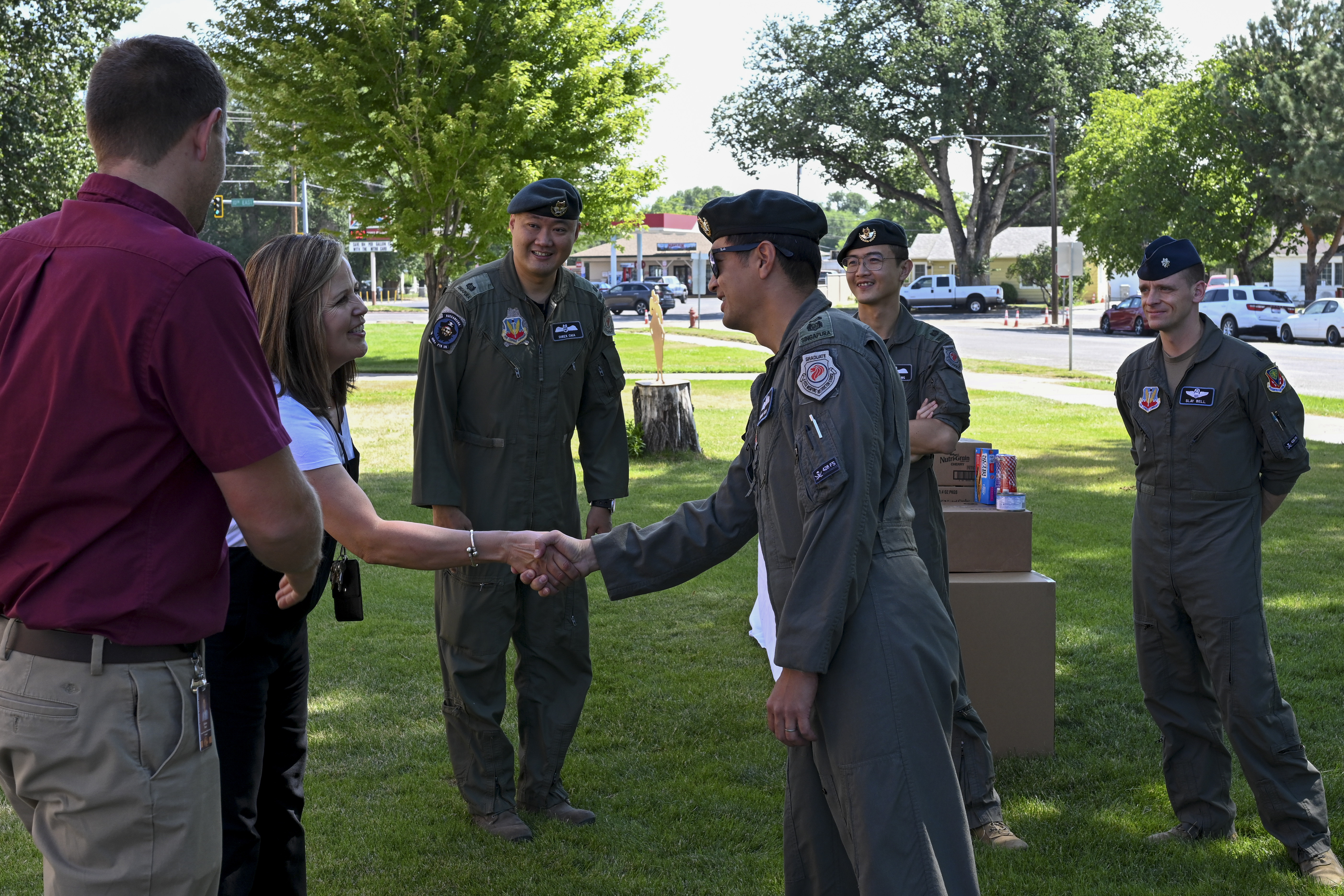 428th Fighter Squadron, RSAF members donate food to community ...