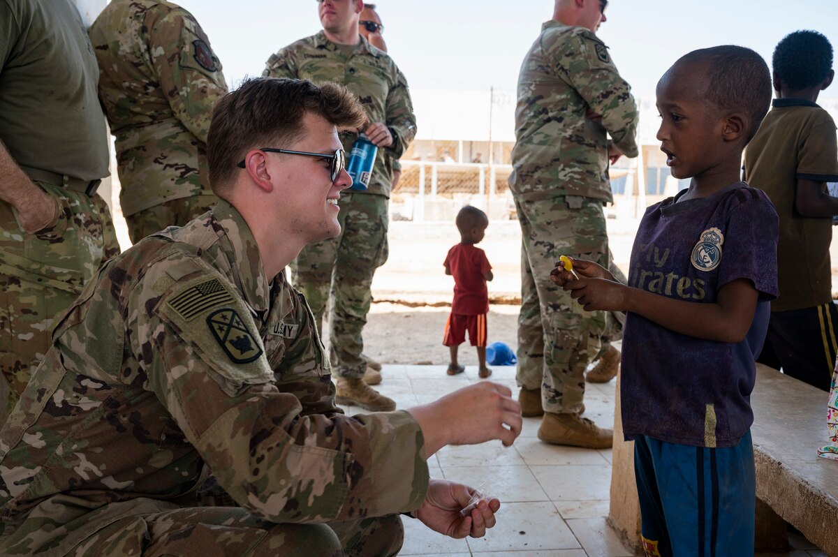 U.S. Airmen and Soldiers build a swing set and relations at Chabelley ...