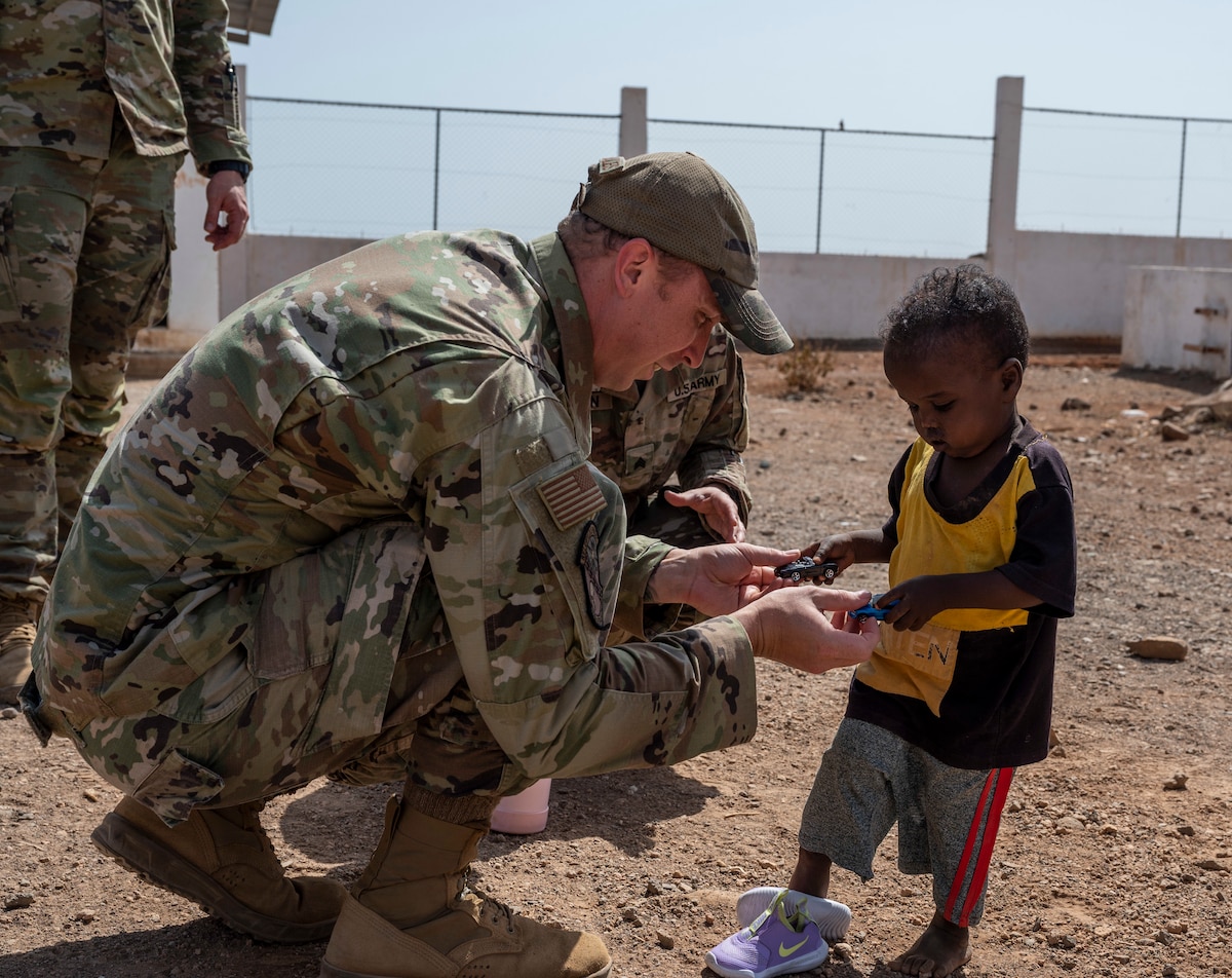 U.S. Airmen and Soldiers build a swing set and relations at Chabelley ...
