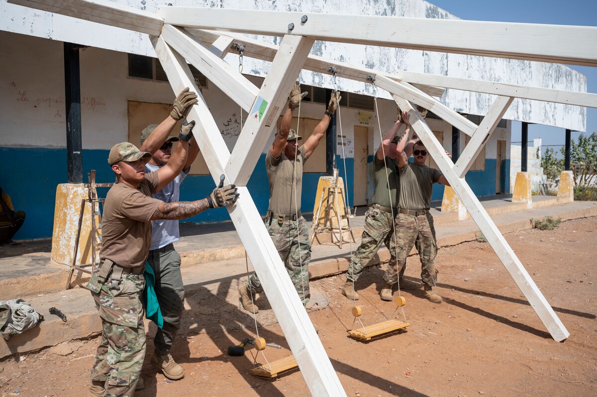 U.S. Airmen and Soldiers build a swing set and relations at Chabelley ...