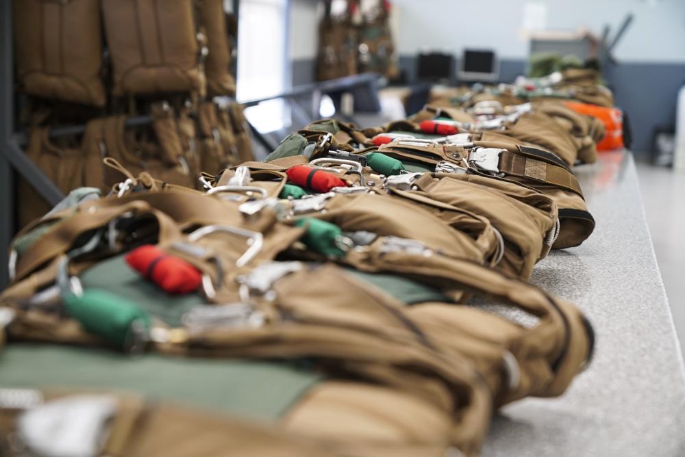 1 SOSS aircrew flight equipment specialists pack life-saving parachutes ...