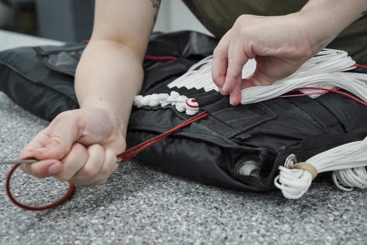 1 SOSS aircrew flight equipment specialists pack life-saving parachutes ...