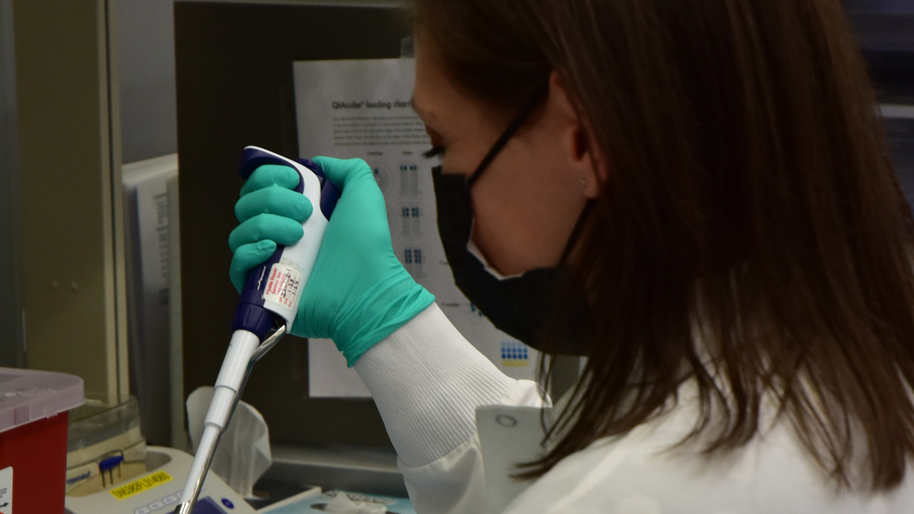 Forensic Scientist examining evidence in the lab