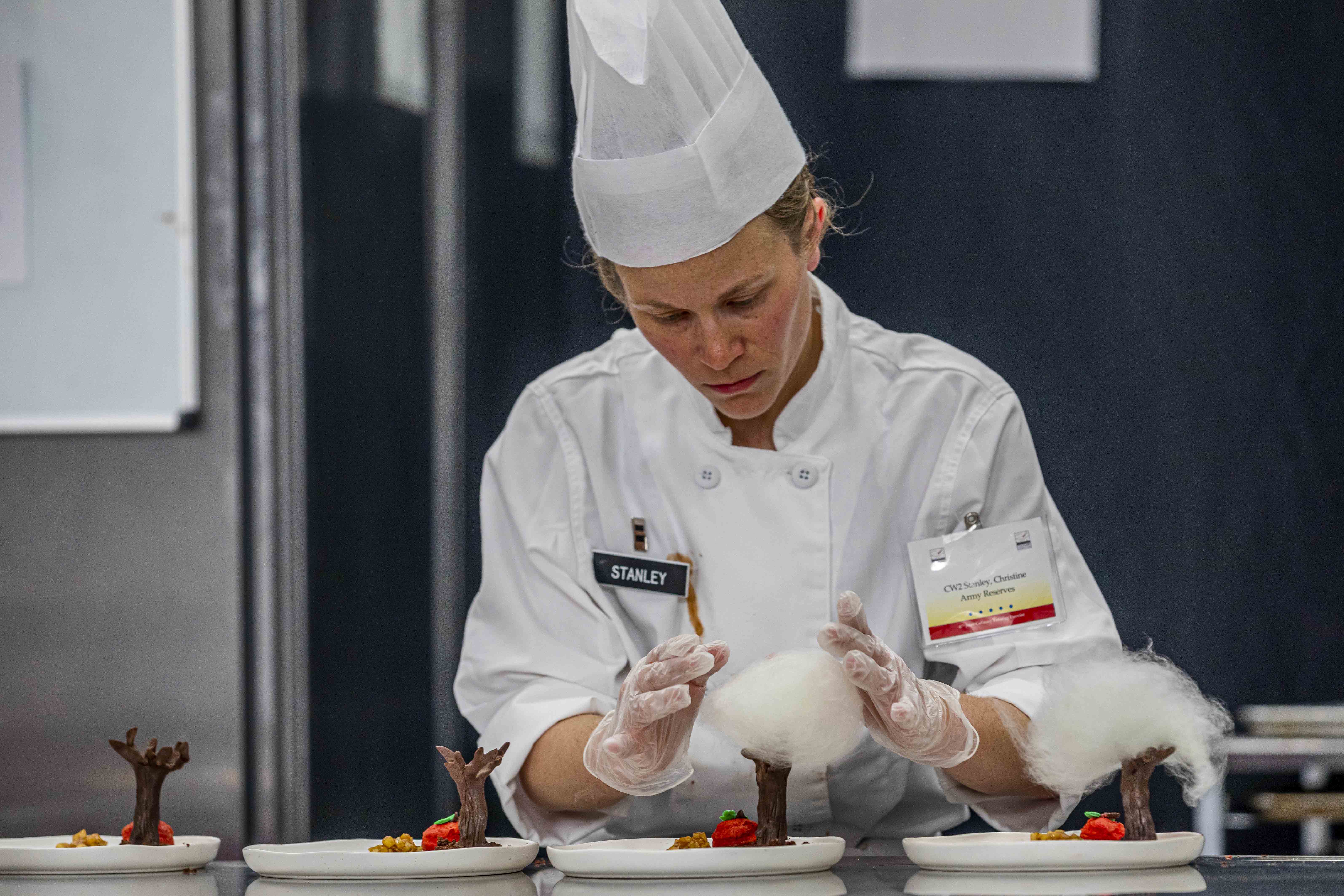 Army Chief Warrant Officer 2 Christine Stanley prepares a dessert ...