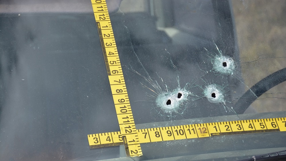Army CID collecting bullet hole evidence