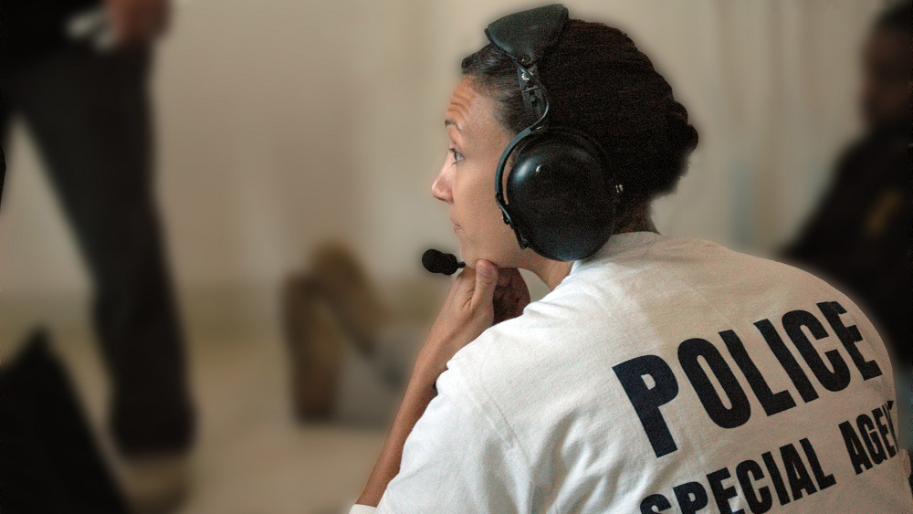Army CID agent monitors negotiation communications at the scene