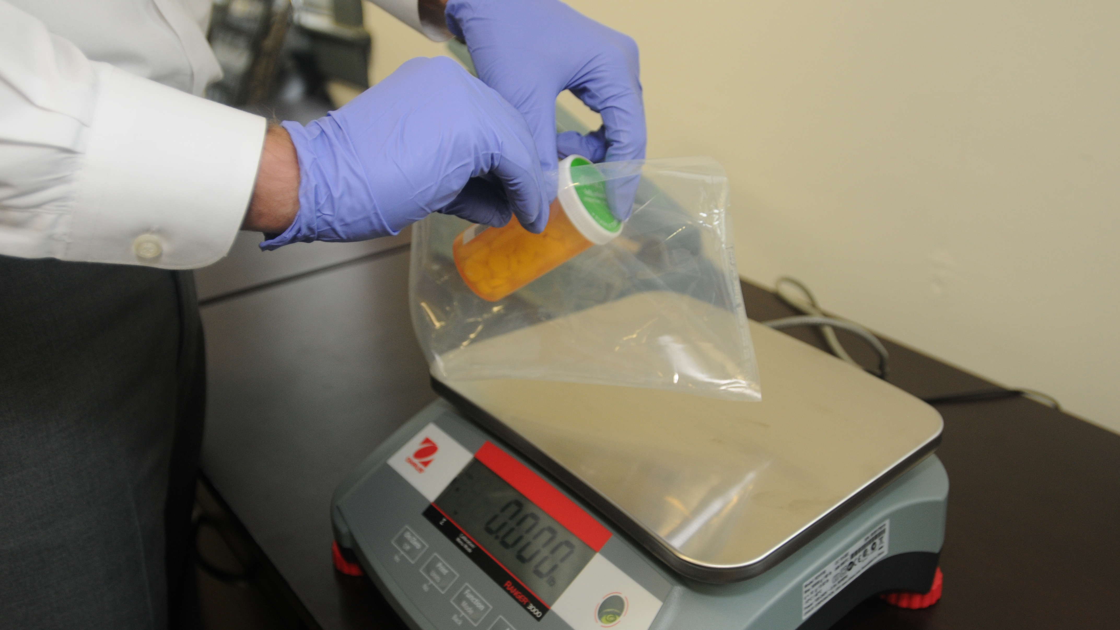 Forensic scientist weighs evidence in the lab