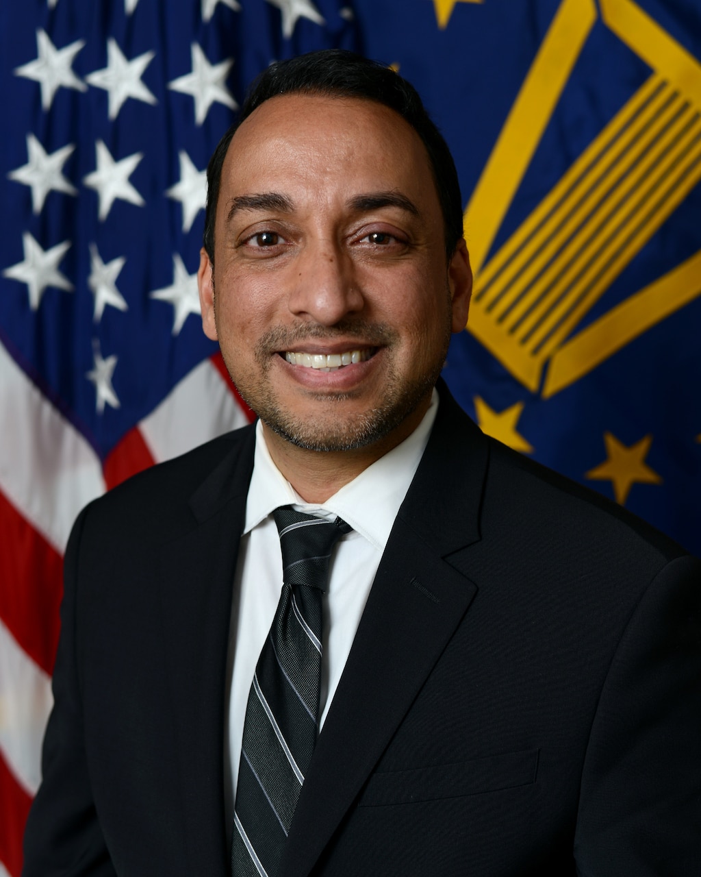 Farooq A. Mitha > U.S. Department of War > Biography