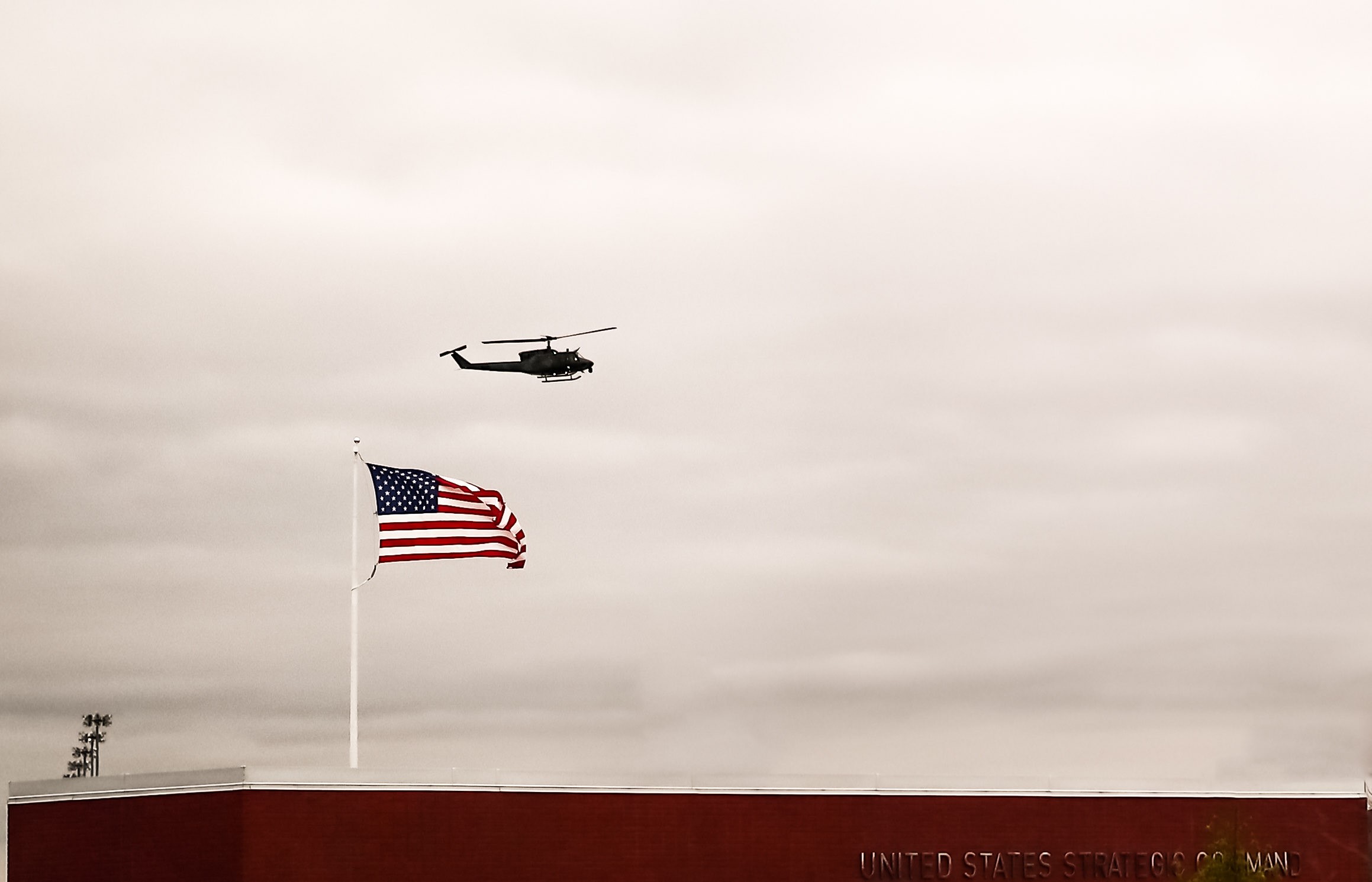 Huey flying with American pride