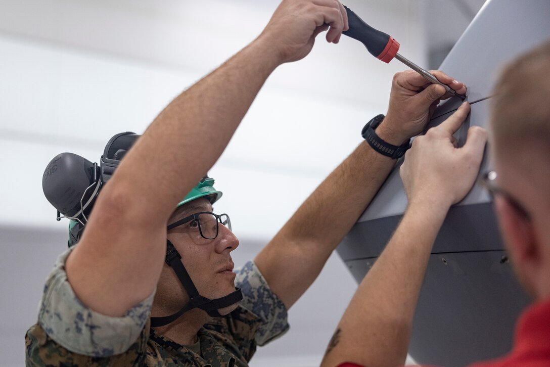 U.S. Marines with VMUT-2 familiarize themselves with 2nd MAW’s first delivered MQ-9A Reaper ...