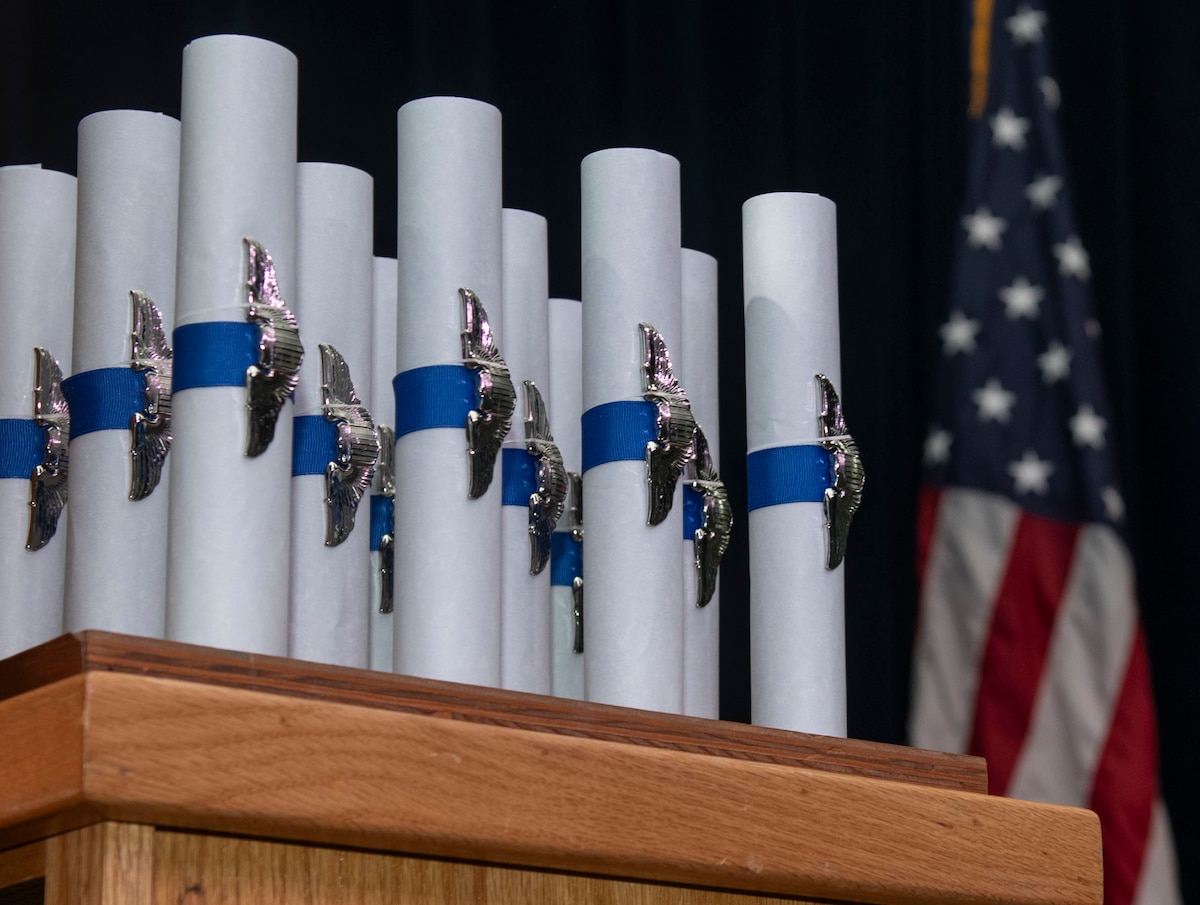 Class 25-03 students pin on wings following their graduation ceremony ...