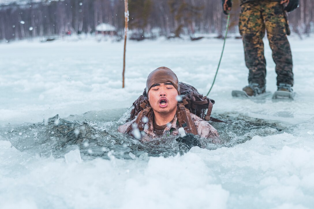 U.S. Marines and Sailors execute an ice-breaker drill before Exercise ...