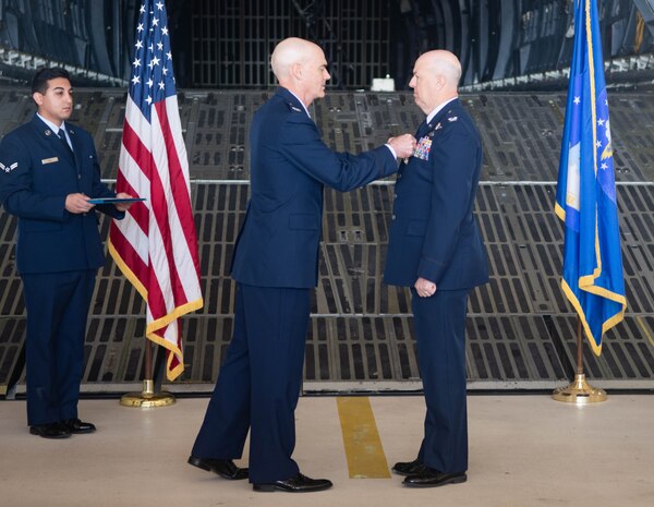 Col. William Gutermuth, 433rd Airlift Wing commander, presents the ...