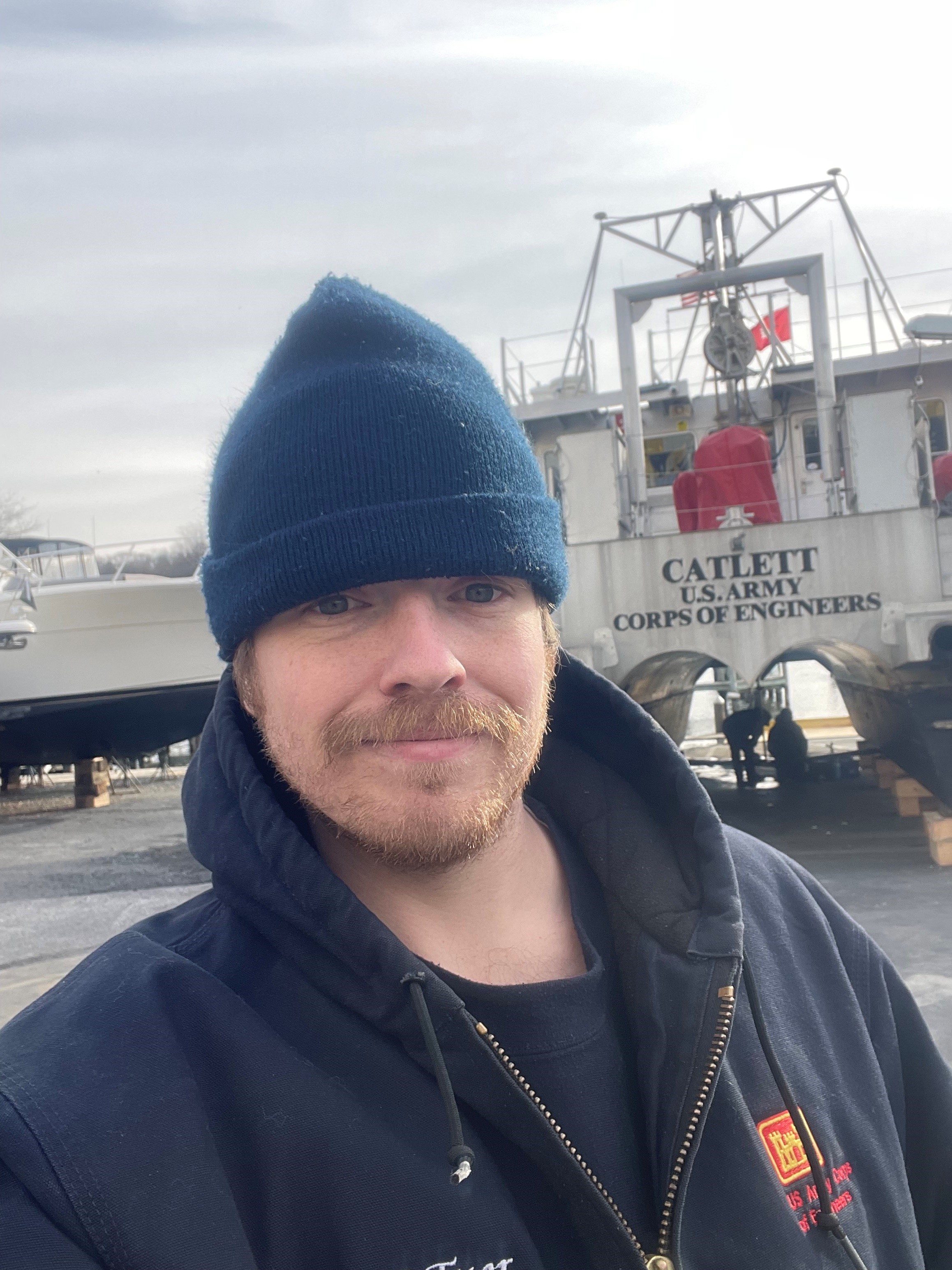 Jacob Tuer, CATLETT assistant operator poses with the survey vessel.