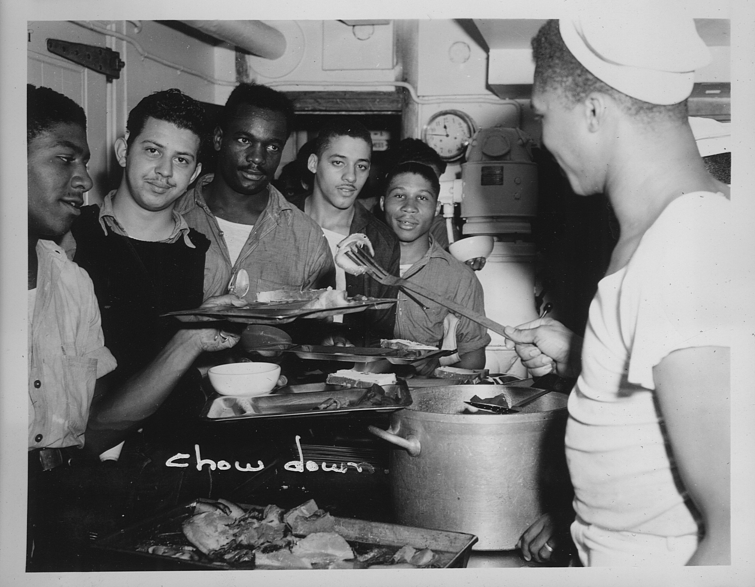 "Chow Down" -- Cooks serving the crew from the galley aboard USS SEA ...